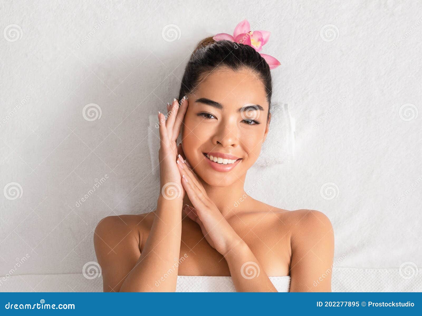 Beautiful Asian Woman Lying On Massage Table At Spa Salon Top View