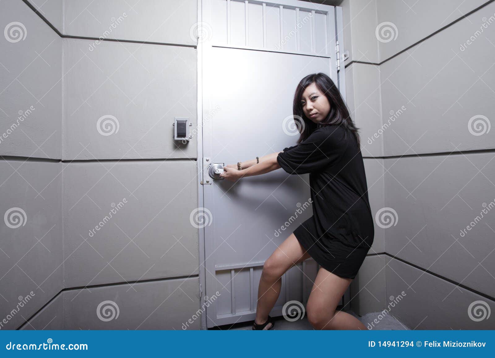Young Asian Woman Pulling On The Door Stock Images - Image: 14941294