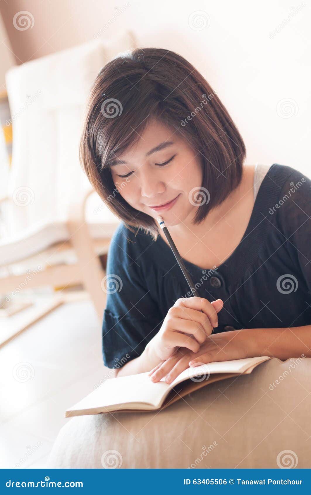 Young asian woman writing. stock photo. Image of body - 63405506