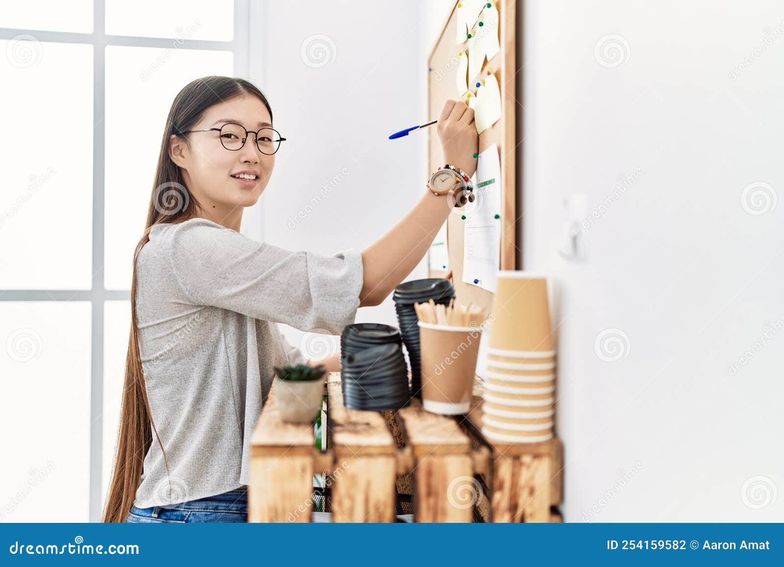 Young Asian Woman Writing on Notice Board at the Office Stock Photo ...