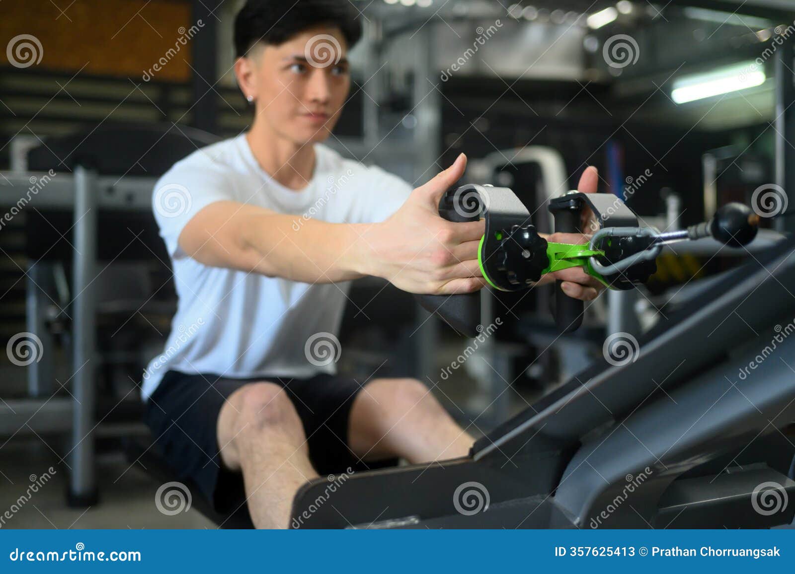 Young Athlete Doing Exercise and Pulling Weights in Seated Cable Row ...