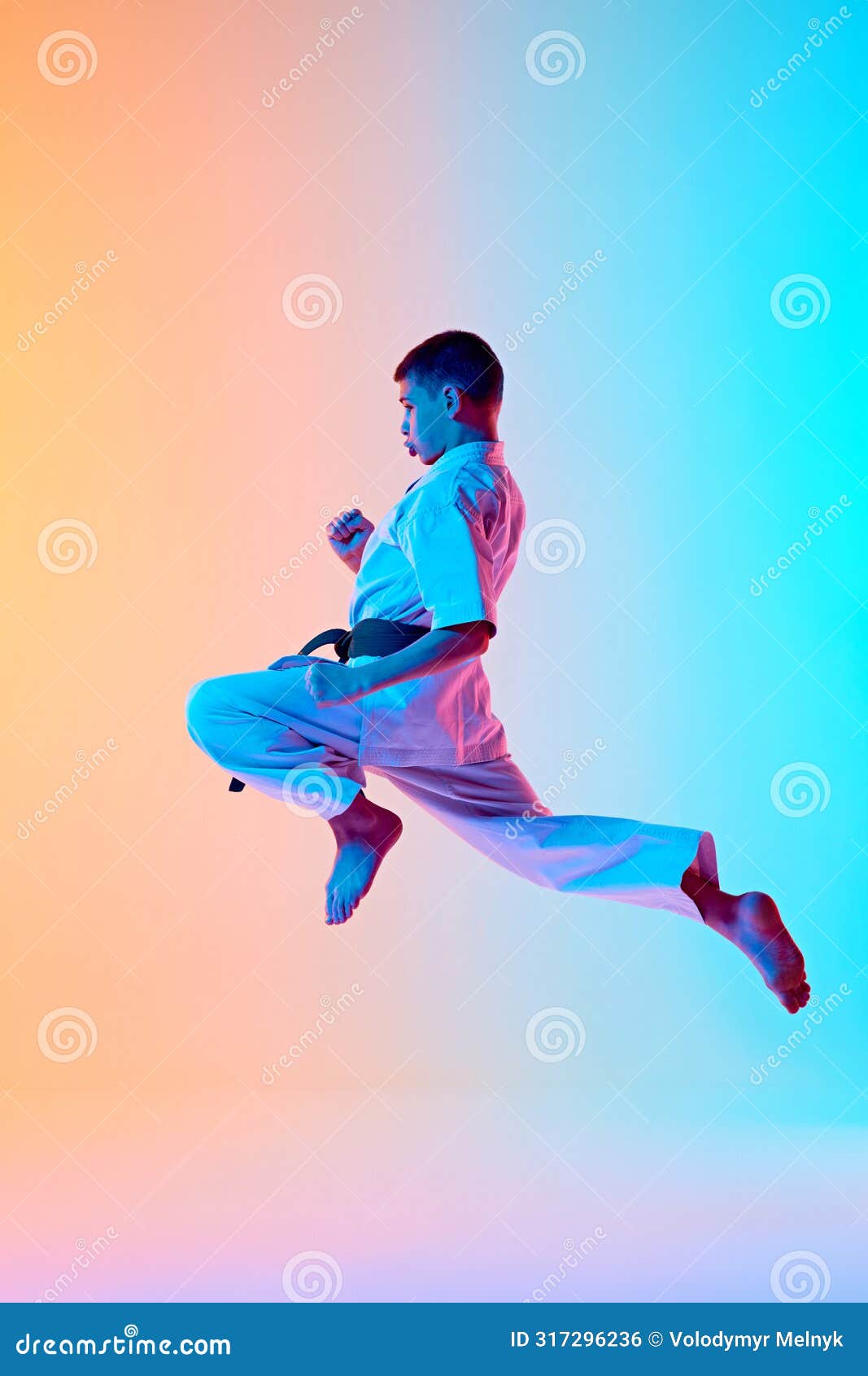 Young Athlete Engaged in Karate Training, Jumping in Dynamic Pose ...
