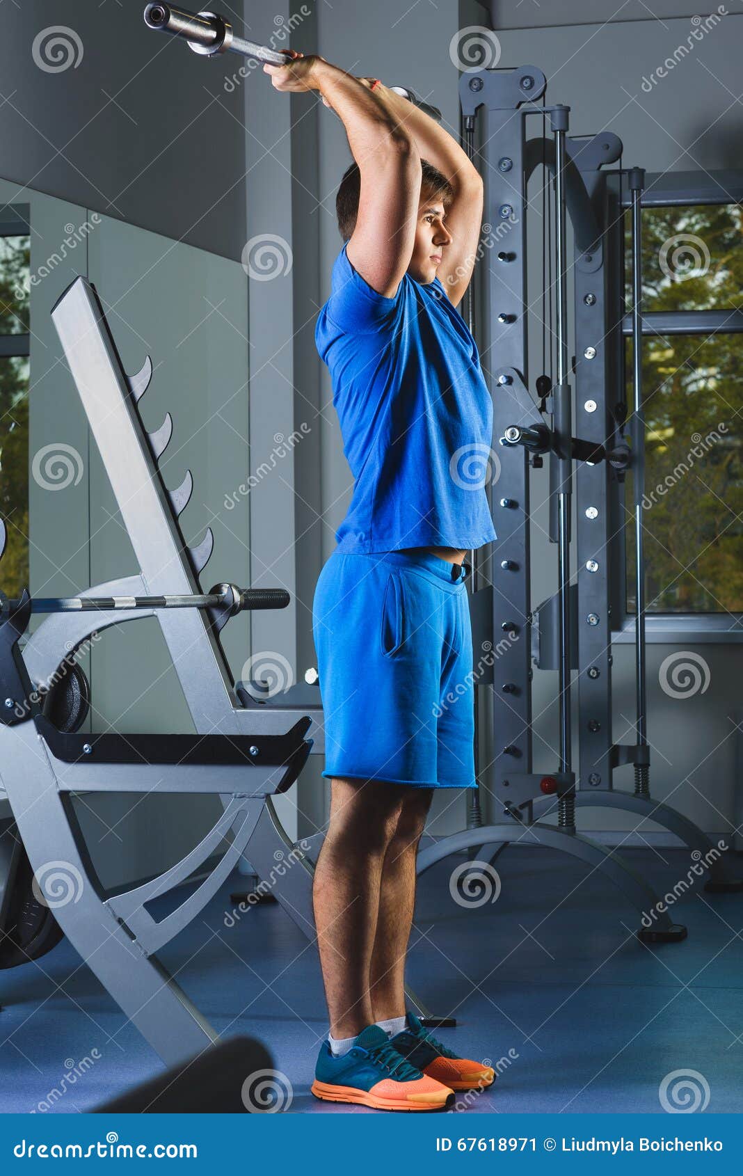 Young Athlete Exercise in the Gym - he is Performing Triceps Exercises ...