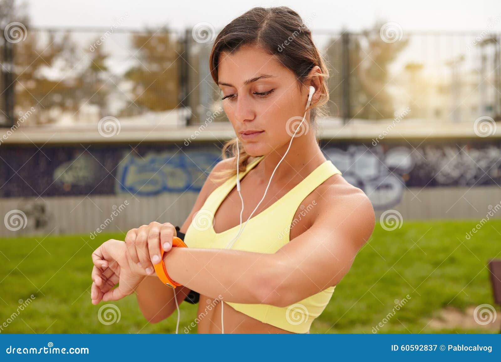 Young Athlete Looking at Smart Watch Outdoors Stock Image - Image of ...