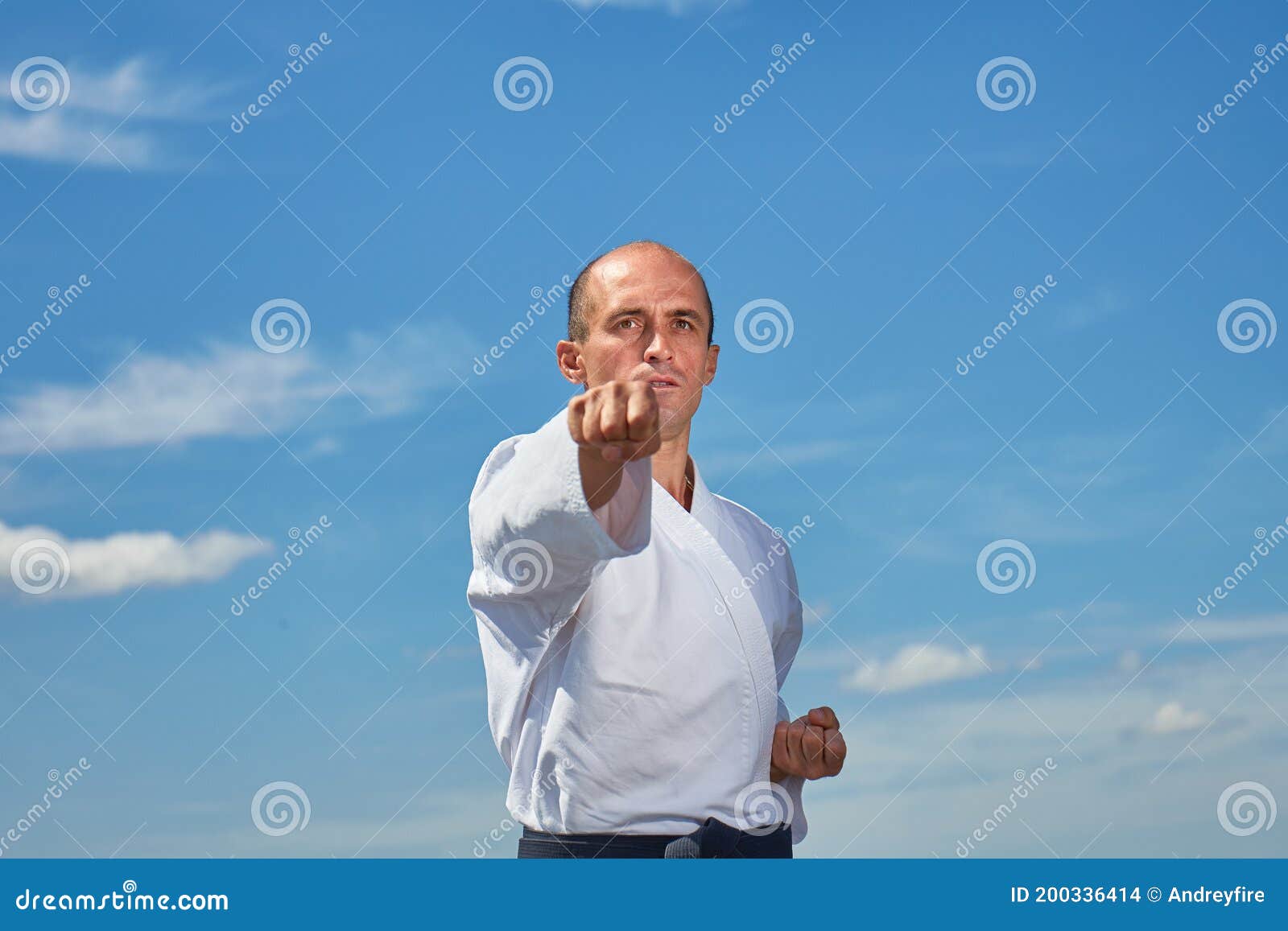Young Athlete Performs a Punch Against the Blue Sky Stock Photo - Image ...