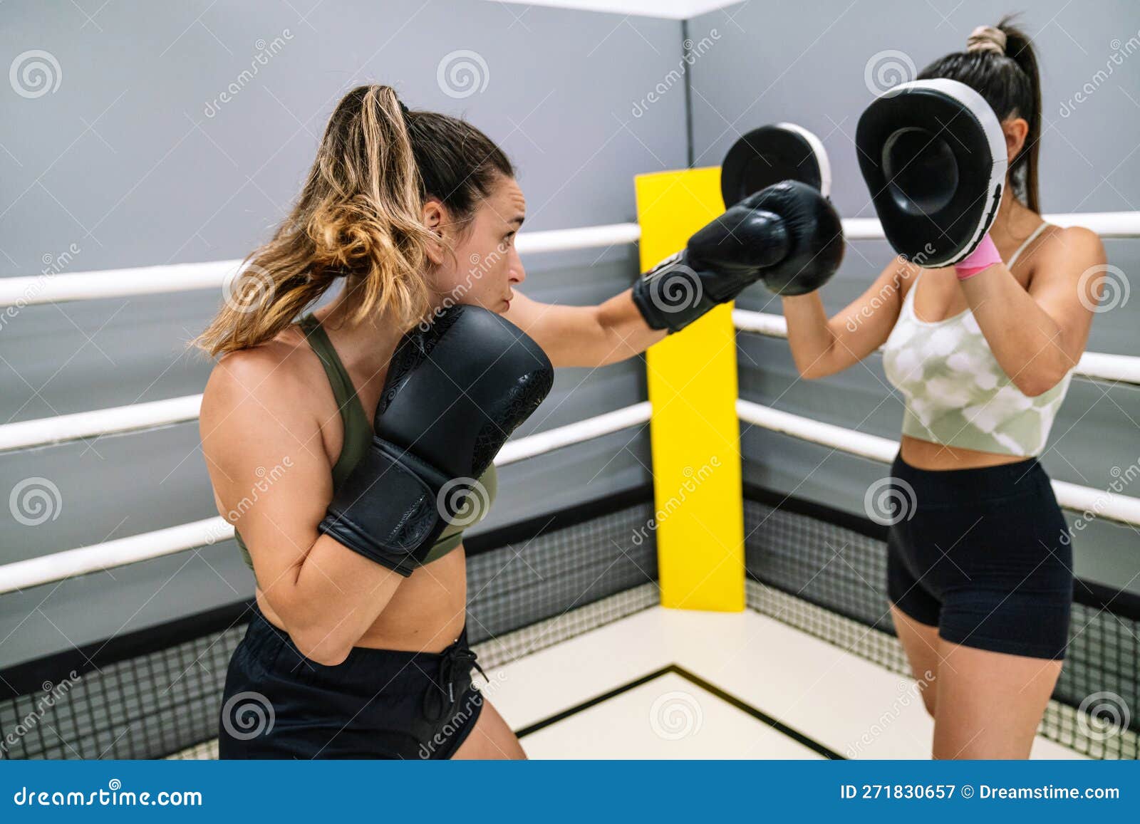 Young Athlete Practicing Boxing Punches in Pair with Instructor Inside ...