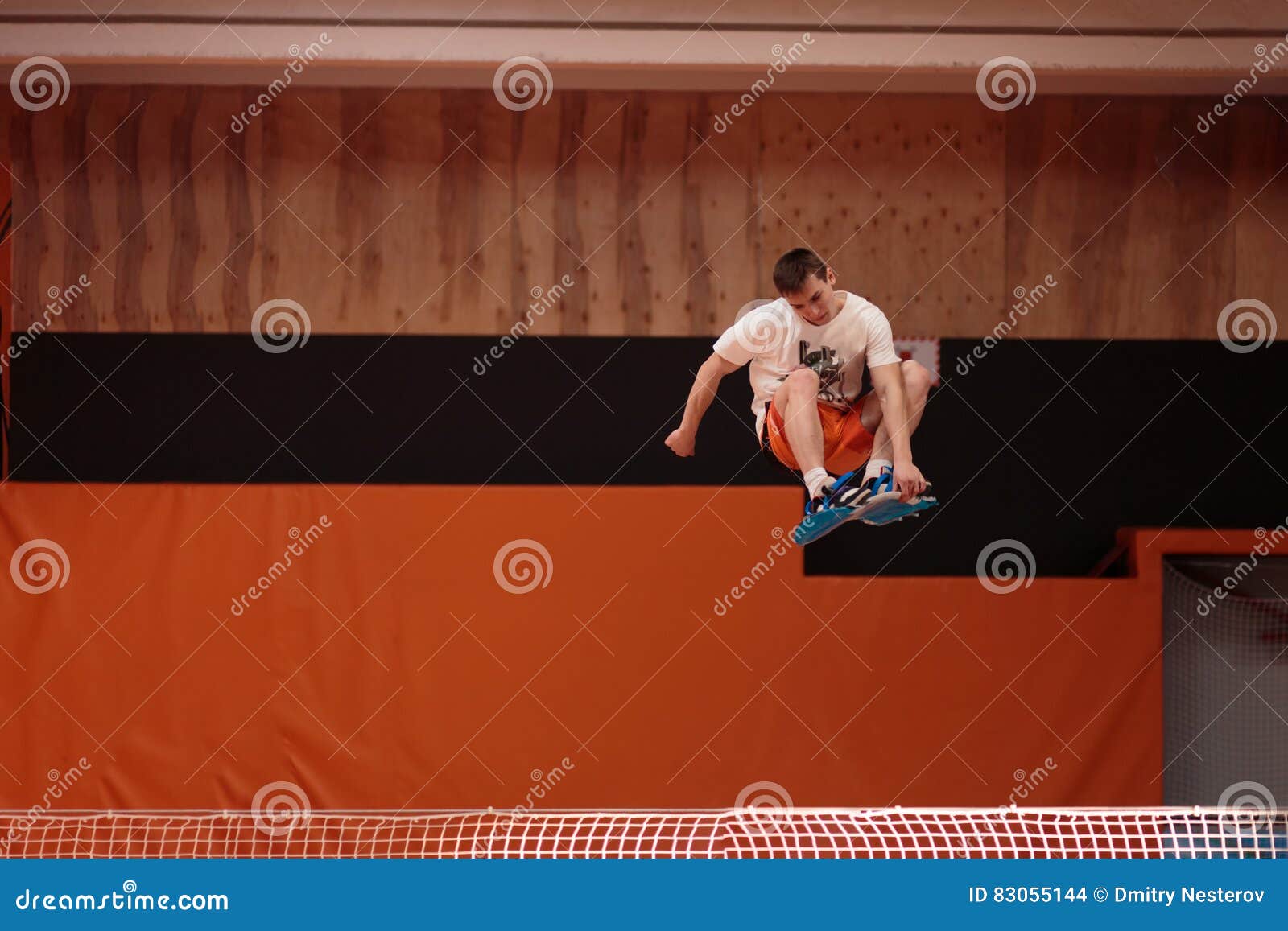 Young Athlete on the Trampoline in Graceful Flight. Stock Photo - Image ...
