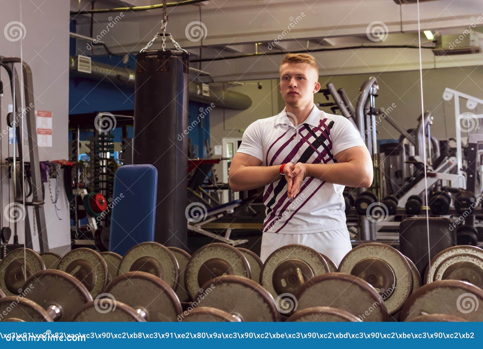 Young Athlete Warming and Chooses Dumbbells before Starting Exercise ...