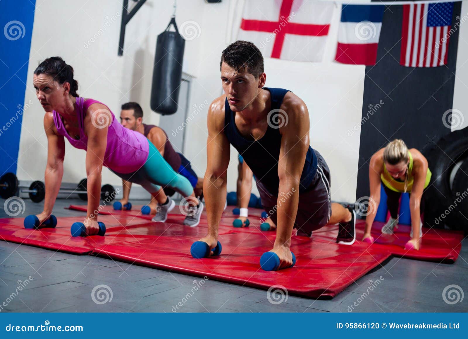 Young Athletes Practicing Push Ups on Dumbbells Stock Photo - Image of ...