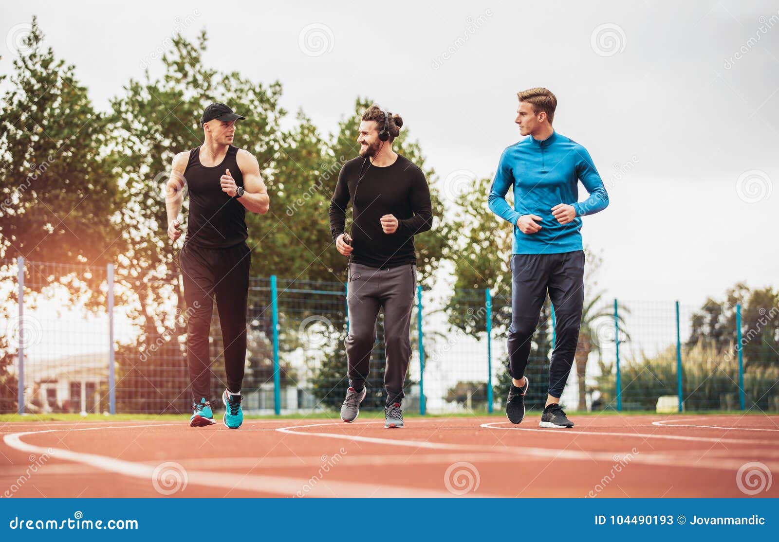 Athletes Practicing a Run on Athletics Stadium Track. Stock Image ...