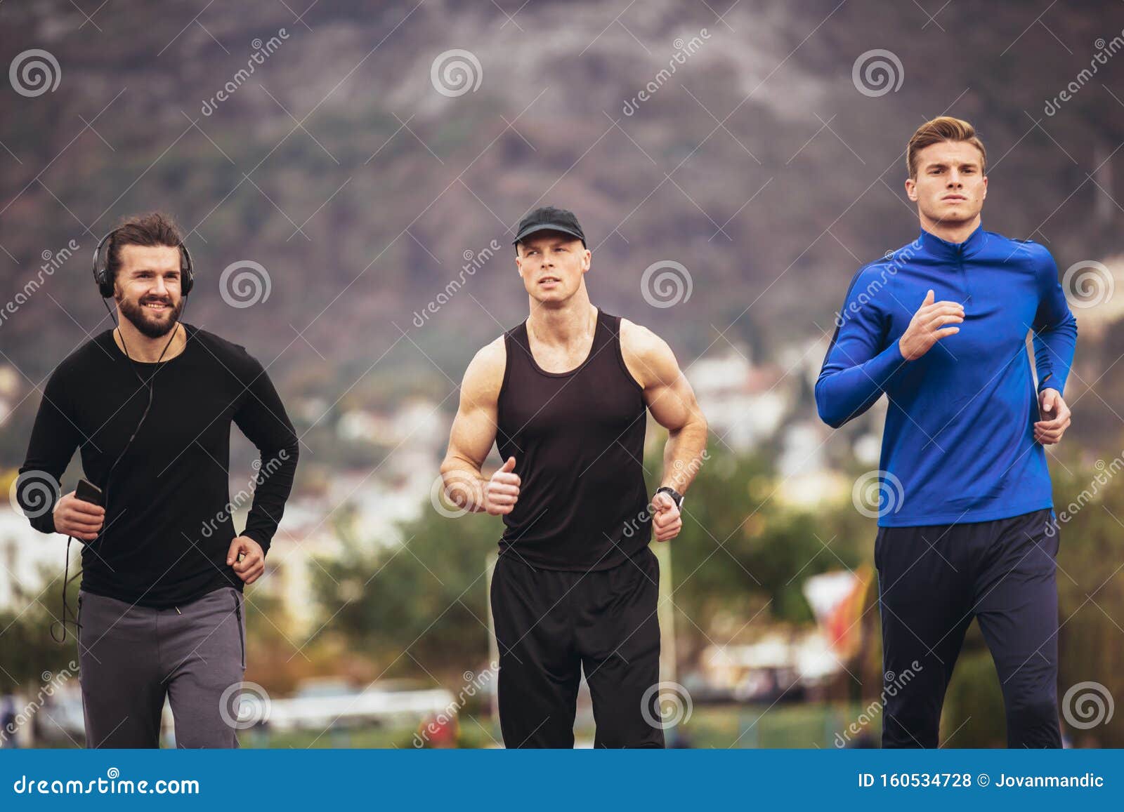 Athletes Practicing a Run on Athletics Stadium Track Stock Photo ...