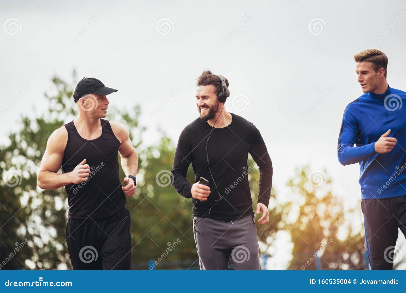 Athletes Practicing a Run on Athletics Stadium Track Stock Photo ...