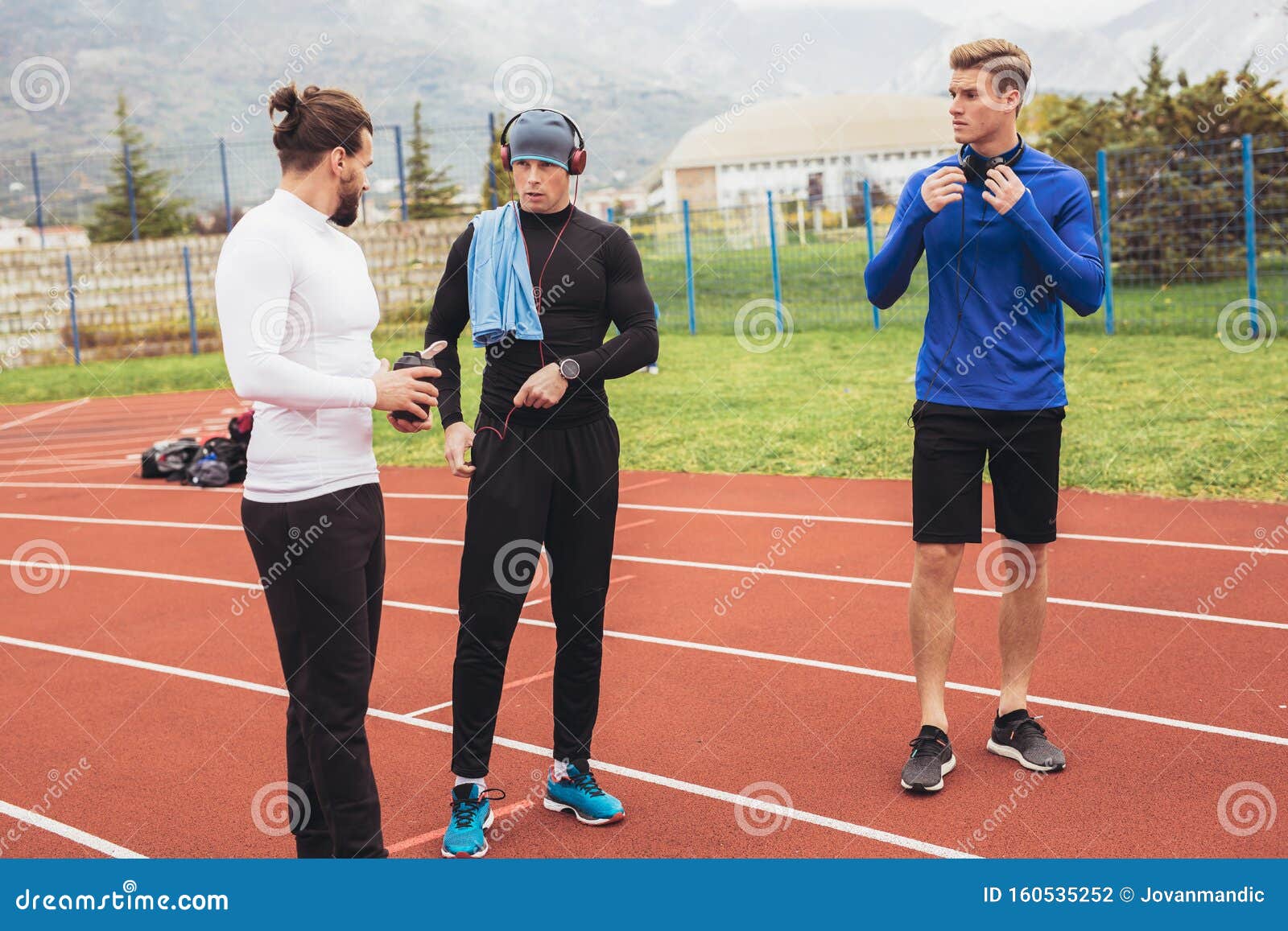 Athletes Practicing a Run on Athletics Stadium Track, Having Break ...