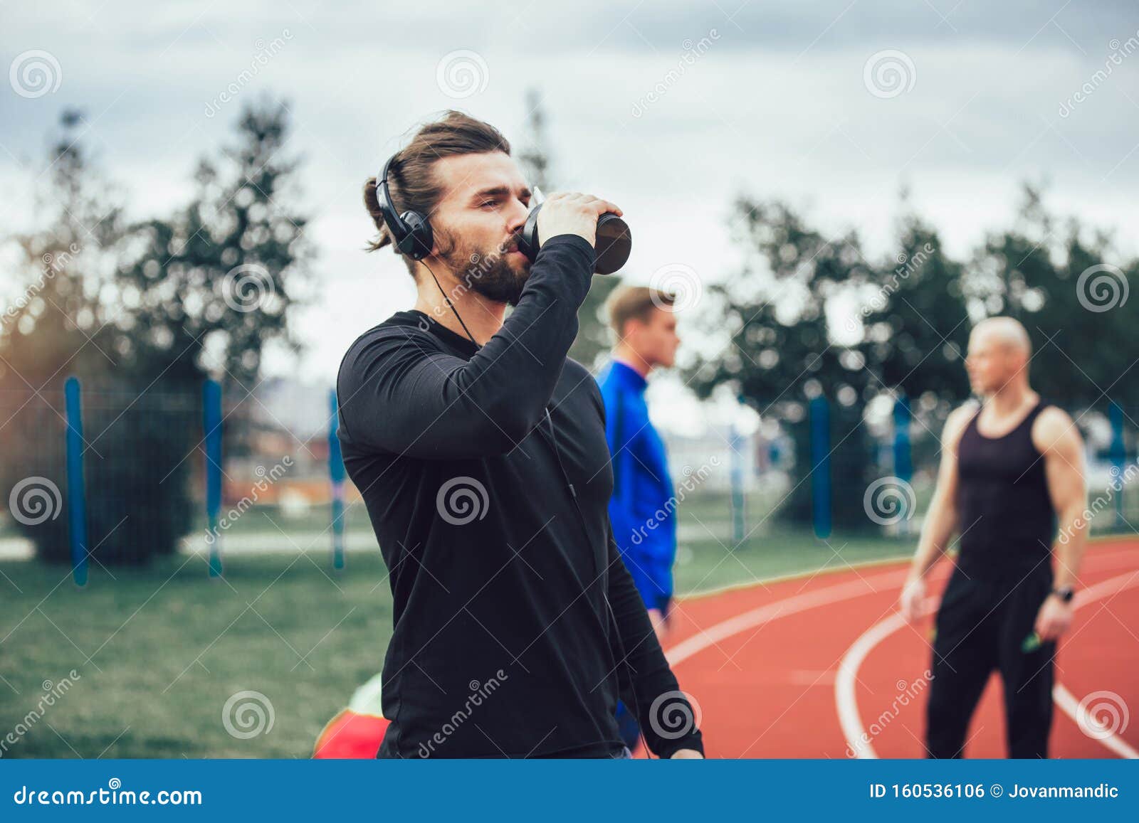Athletes Practicing a Run on Athletics Stadium Track, Having Break ...