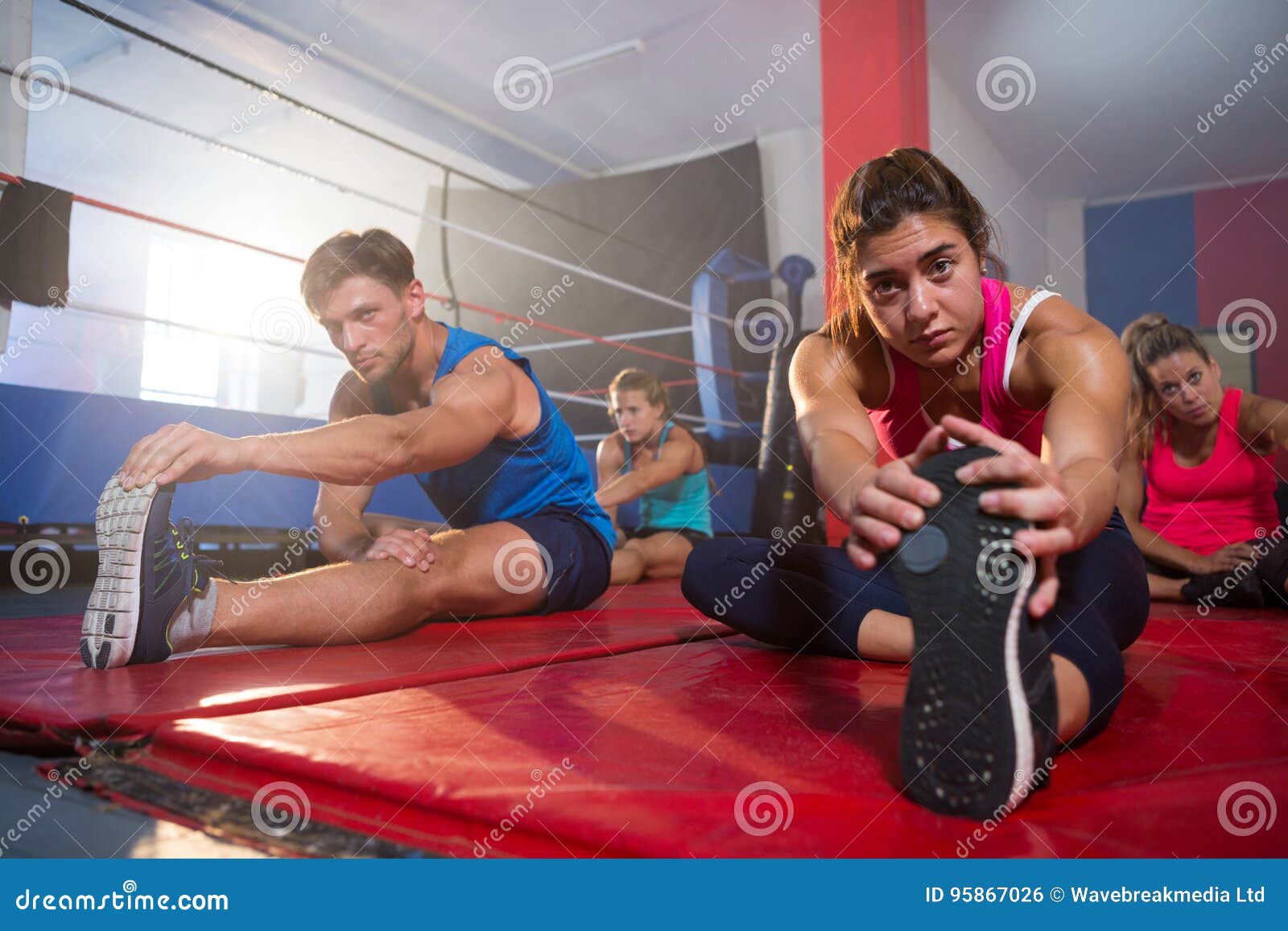 Young Athletes Practicing Stretch Exercise on Mats Stock Photo - Image ...
