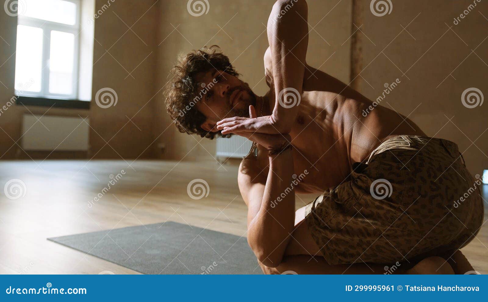 A Young and Athletic Man Does Yoga and Performs Complex Asanas Stock ...