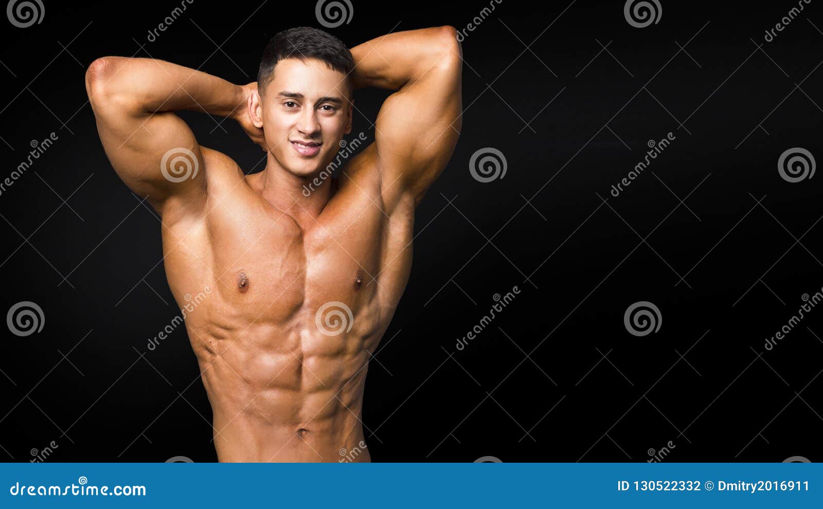 Young Athletic Man with Perfect Abs Over Dark Background Stock Photo ...