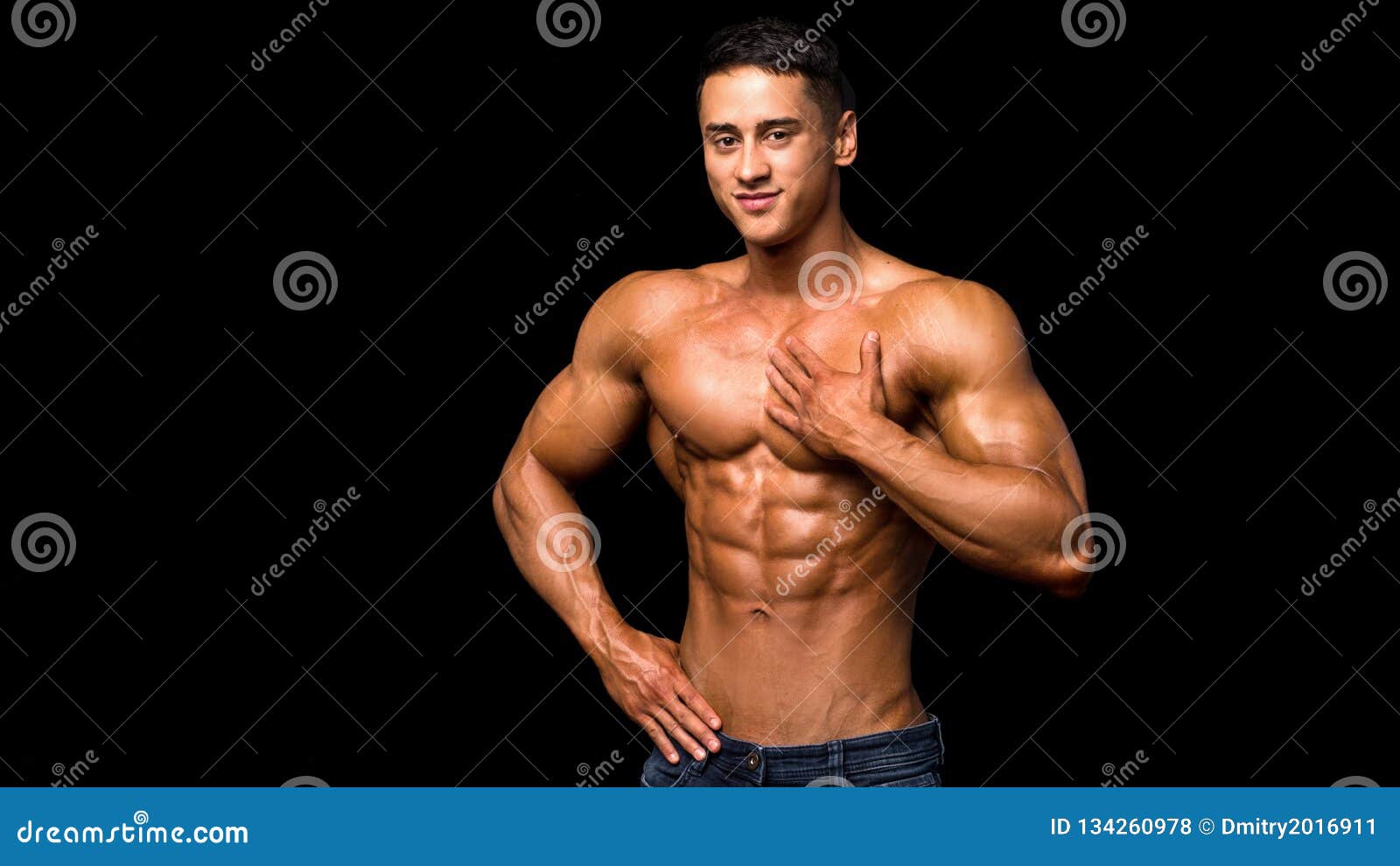 Young Athletic Man with Perfect Abs Over Dark Background. Stock Photo ...