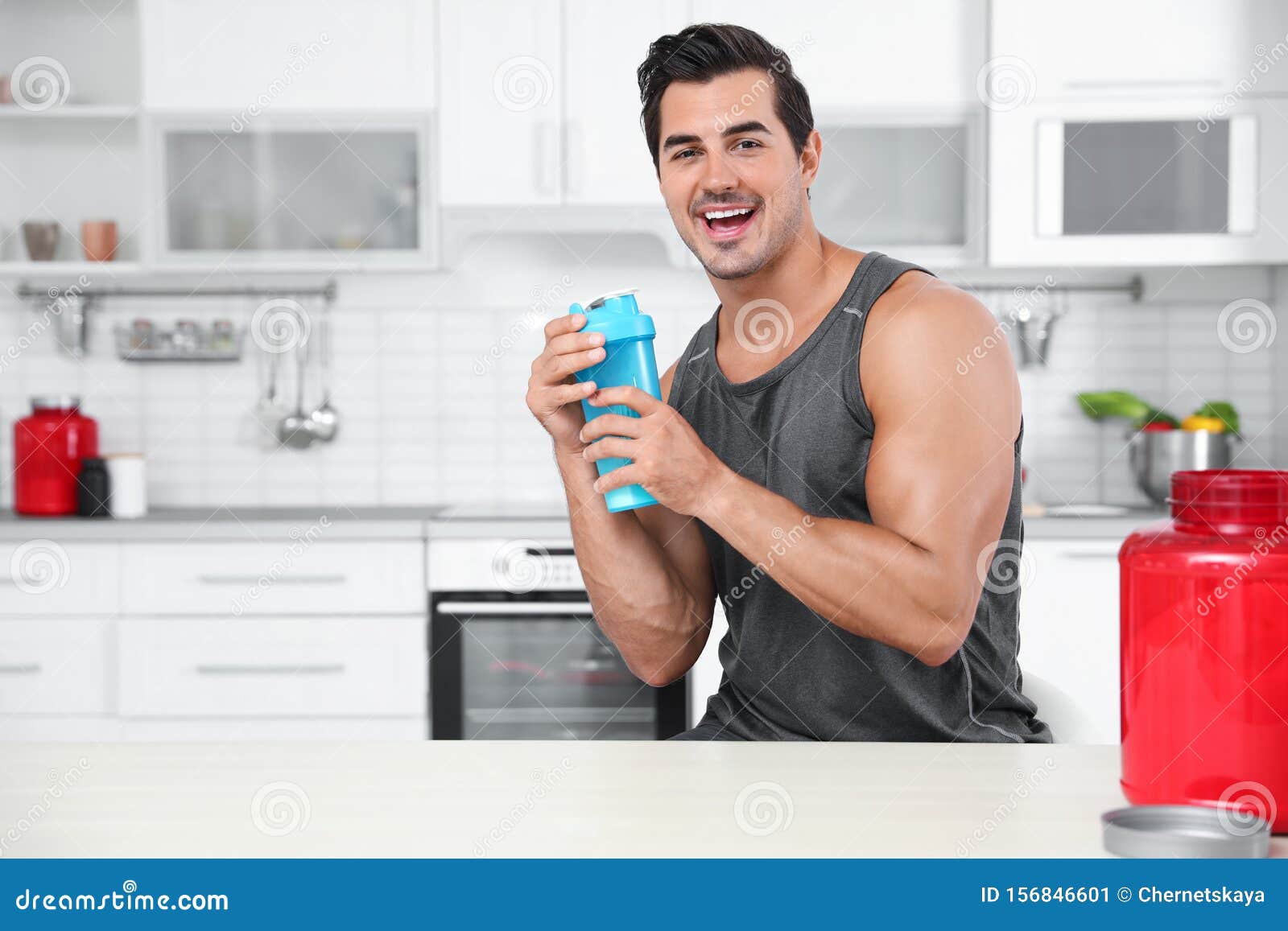 Young Athletic Man with Protein Shake in Kitchen, Space for Text Stock ...