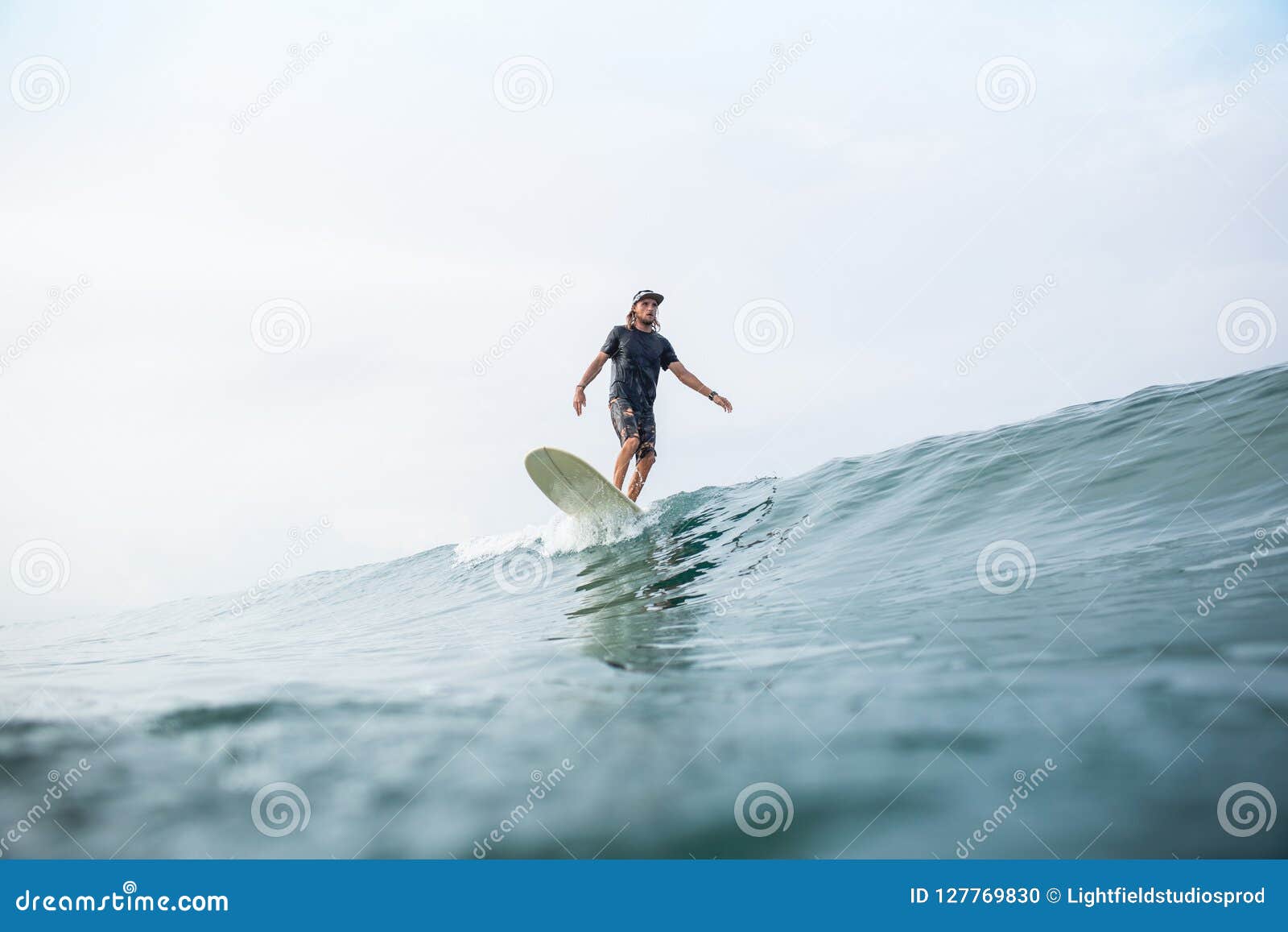 Young Athletic Man Riding Surfboard in Ocean during Stock Photo - Image ...