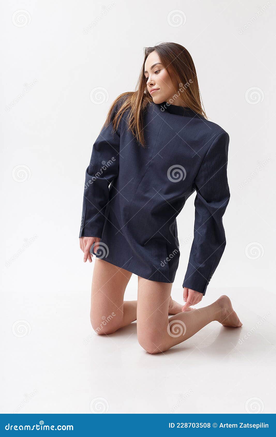 Young Attractive Asian Woman In Blue Suit Standing On Her Knees At