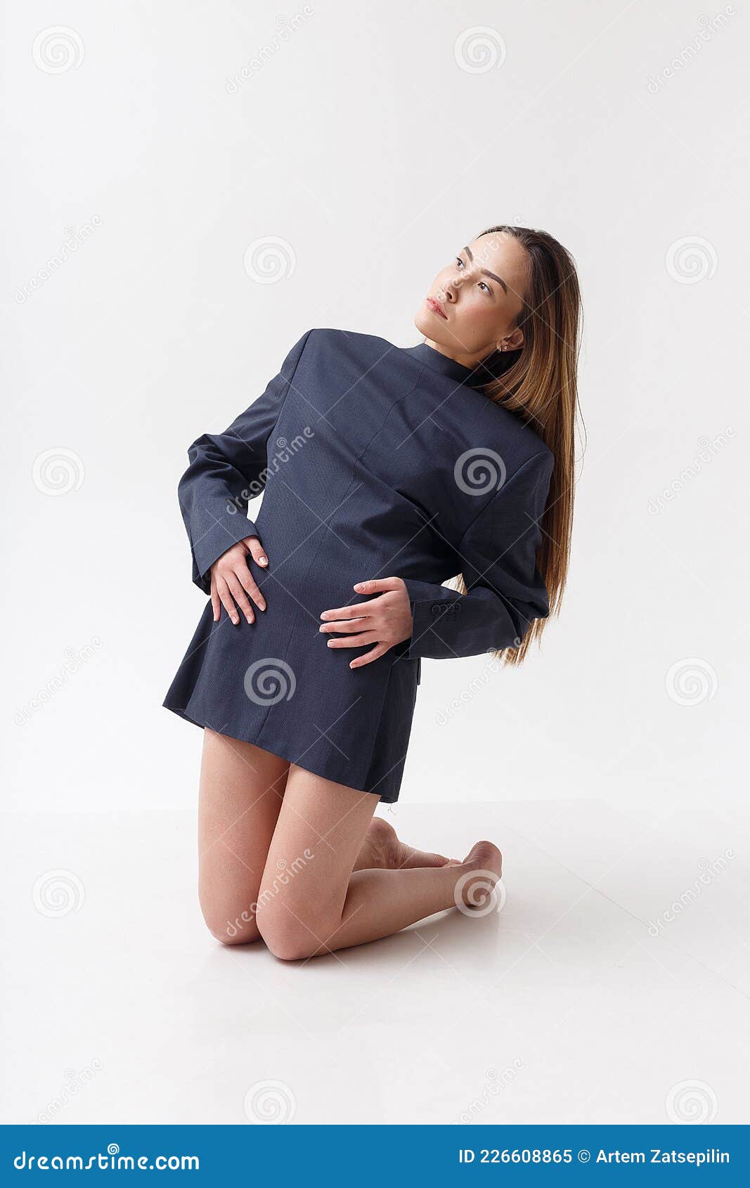 Young Attractive Asian Woman In Blue Suit Standing On Her Knees At