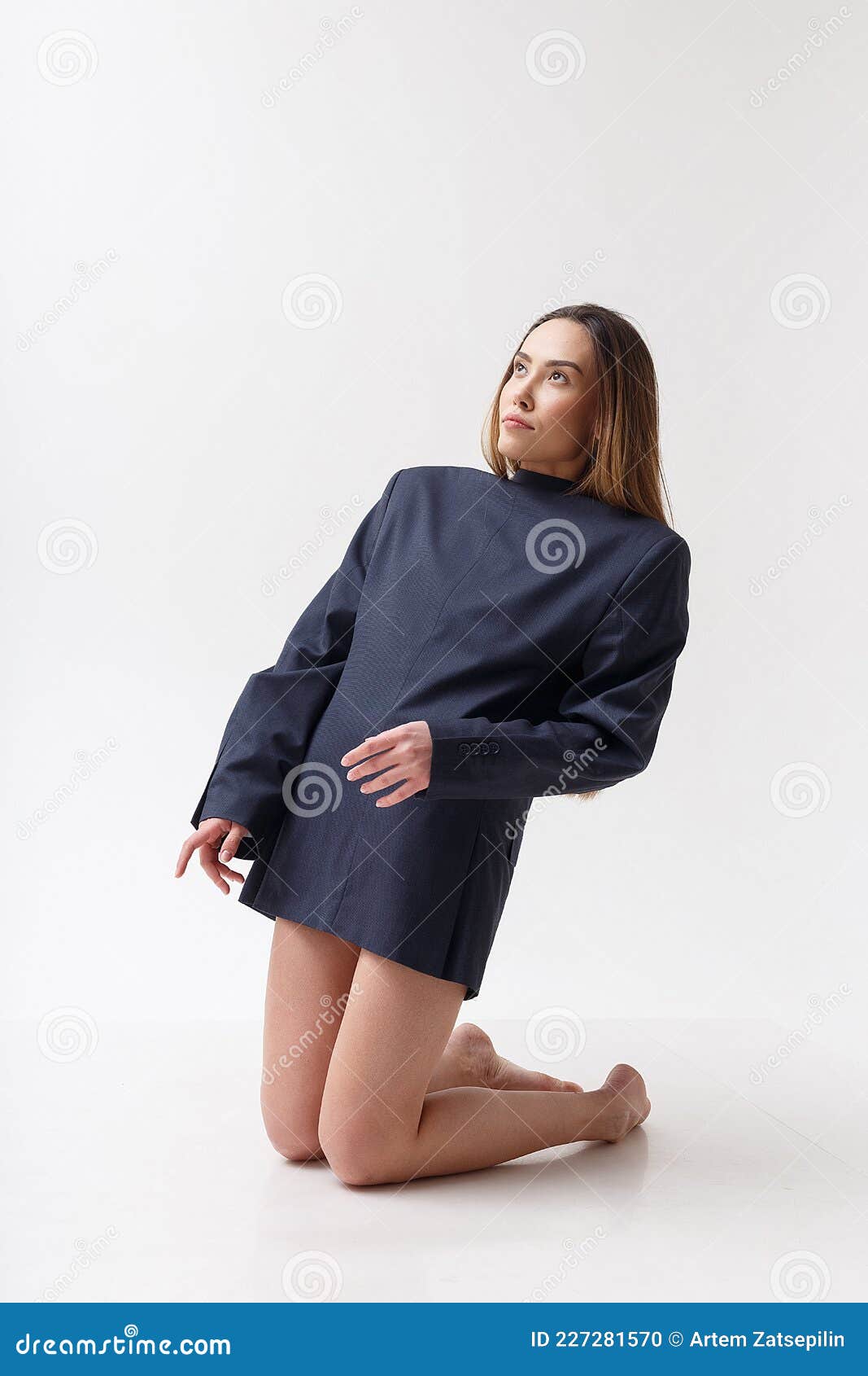 Young Attractive Asian Woman In Blue Suit Standing On Her Knees At