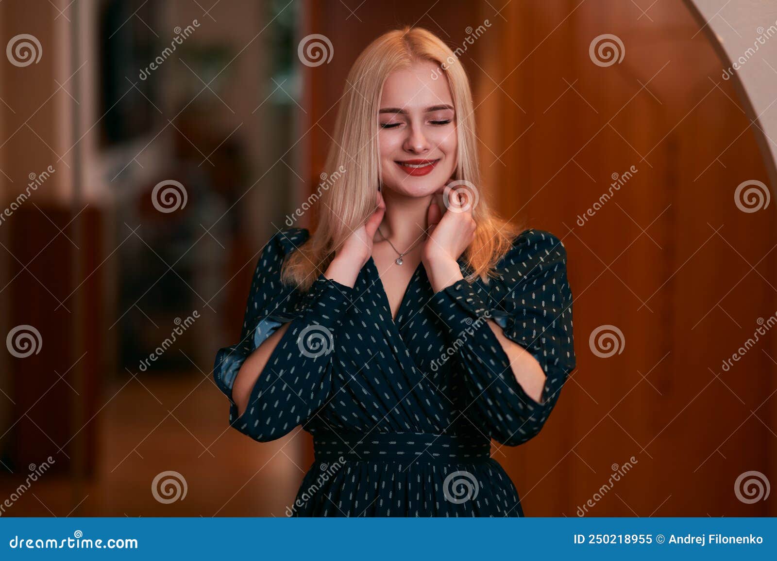 Young Attractive Blonde Woman With Short Hair Posing In A Black Dress
