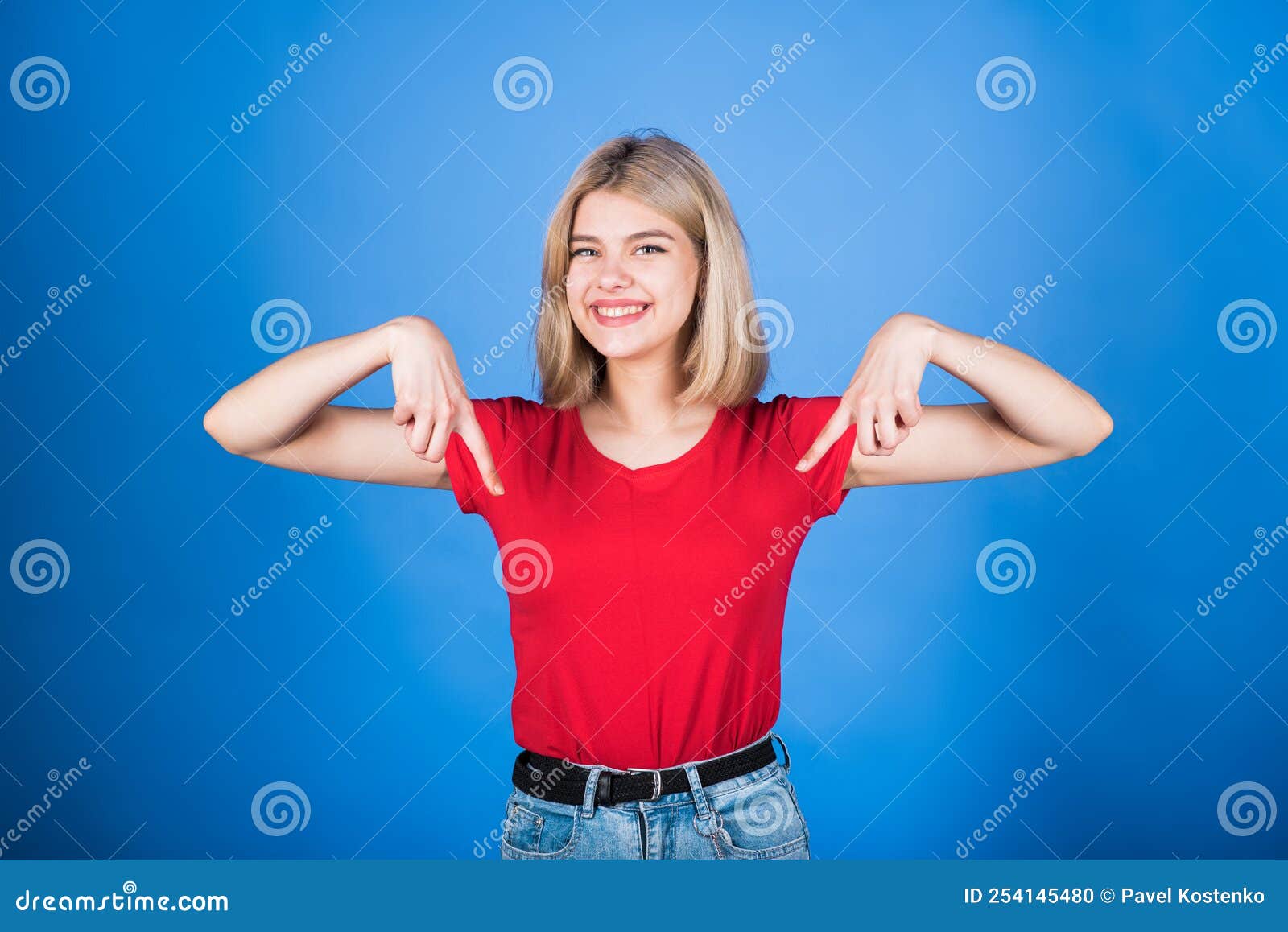 Young And Attractive Caucasian Blonde Girl In Casual Clothes Pointing