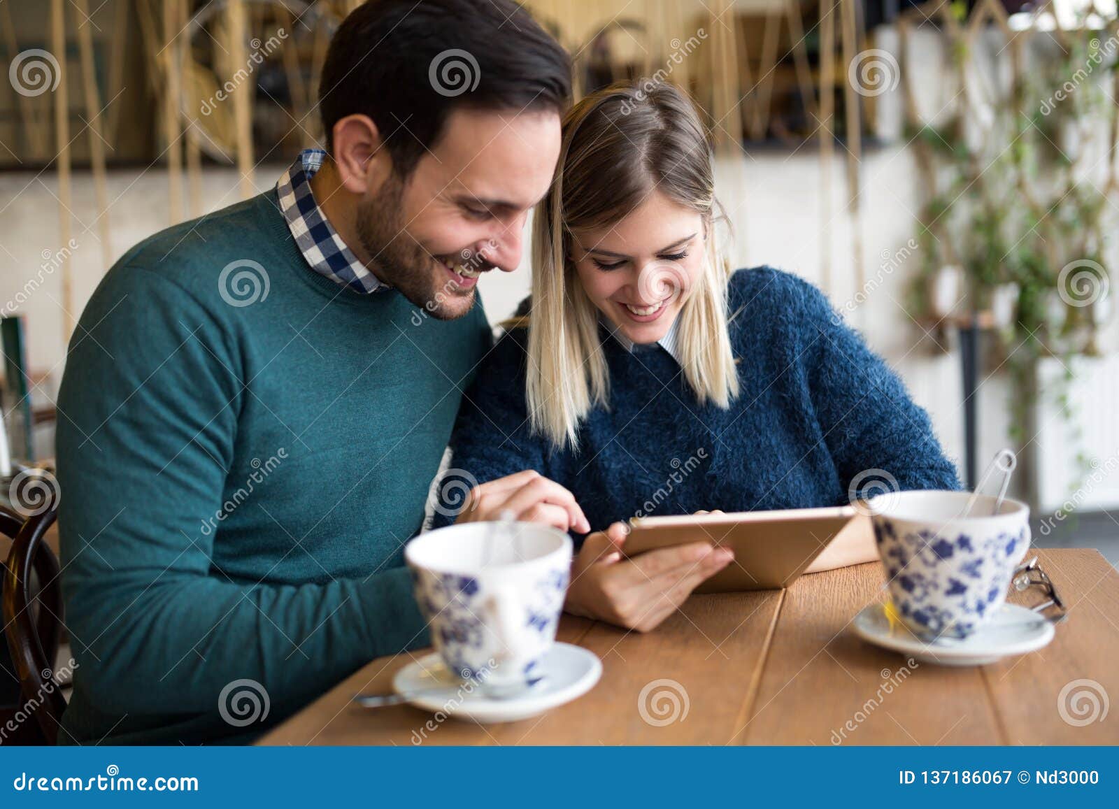 Young Attractive Couple on Date in Coffee Shop Stock Image - Image of ... Young Attractive Couple on Date in Coffee Shop Stock Image - Image of ...
