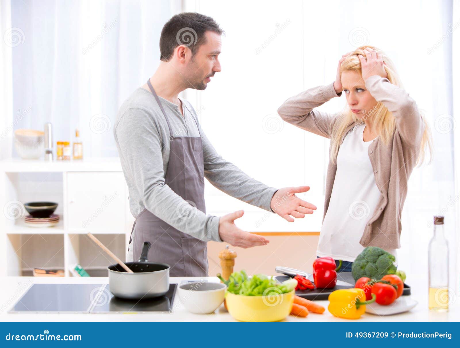 Young Attractive Couple Having an Argue while Cooking Stock Image ...
