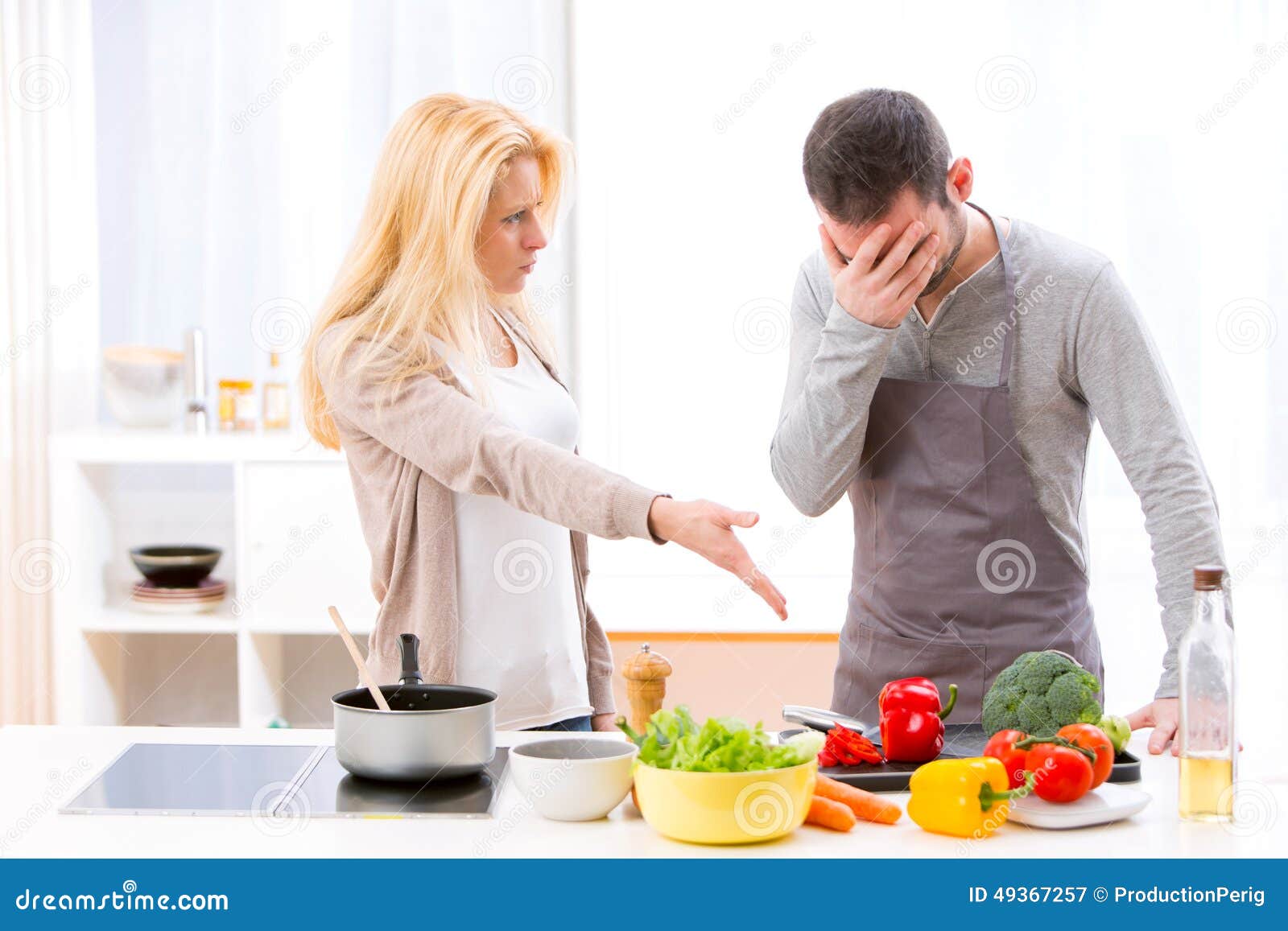 Young Attractive Couple Having an Argue while Cooking Stock Image ...