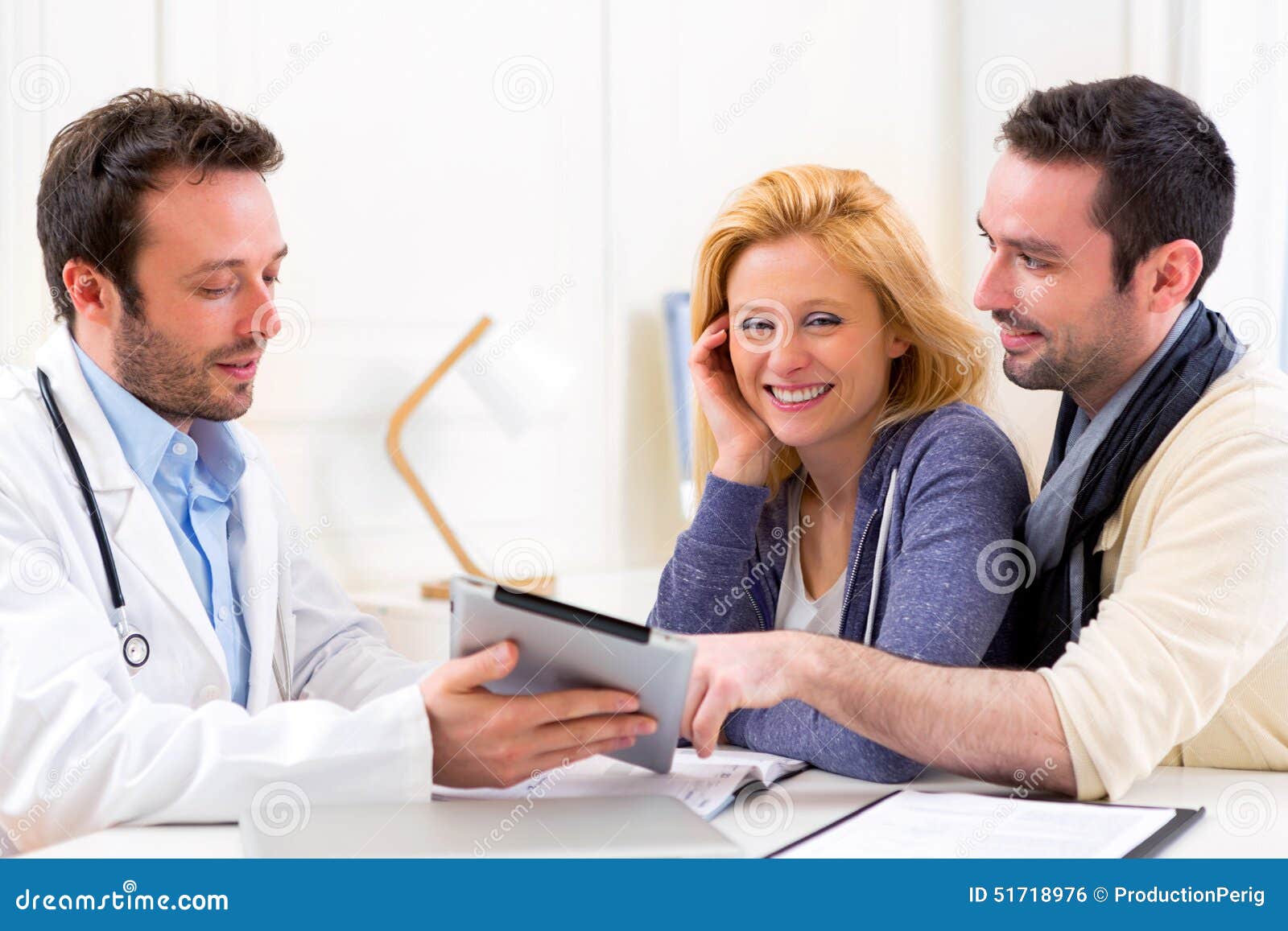 Young Attractive Couple Seeing a Doctor Stock Photo - Image of surgeon ...