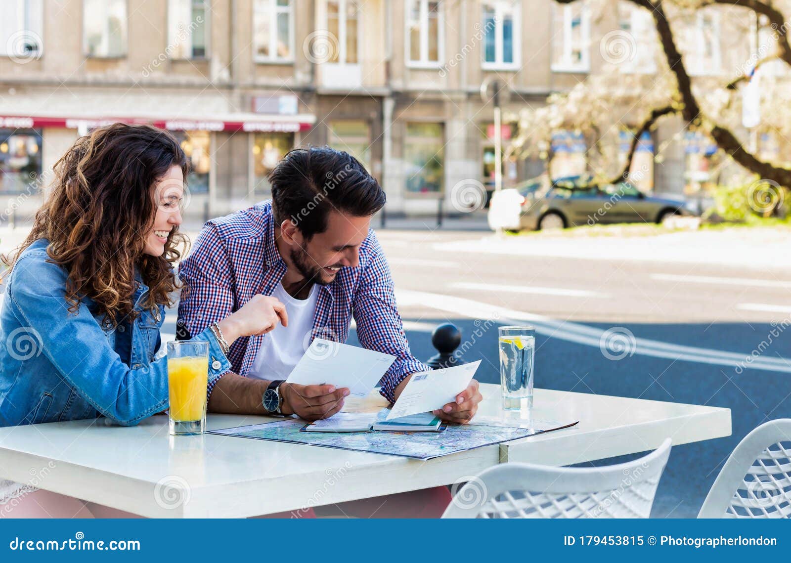 Young Attractive Couple Smiling while Looking at the Menu in Restaurant ...