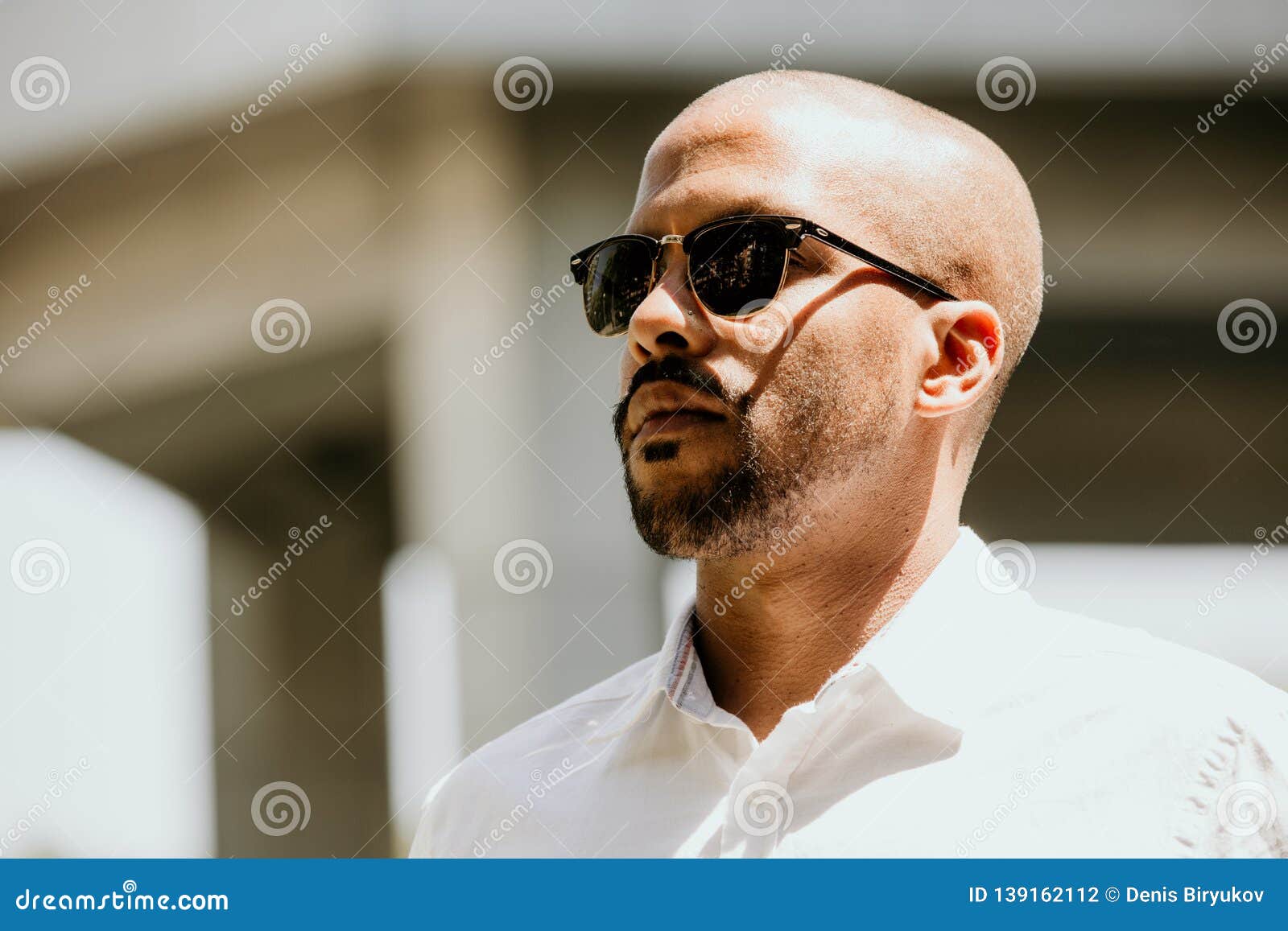 Young Attractive Dark Skinned Male In White Shirt And Sunglasses