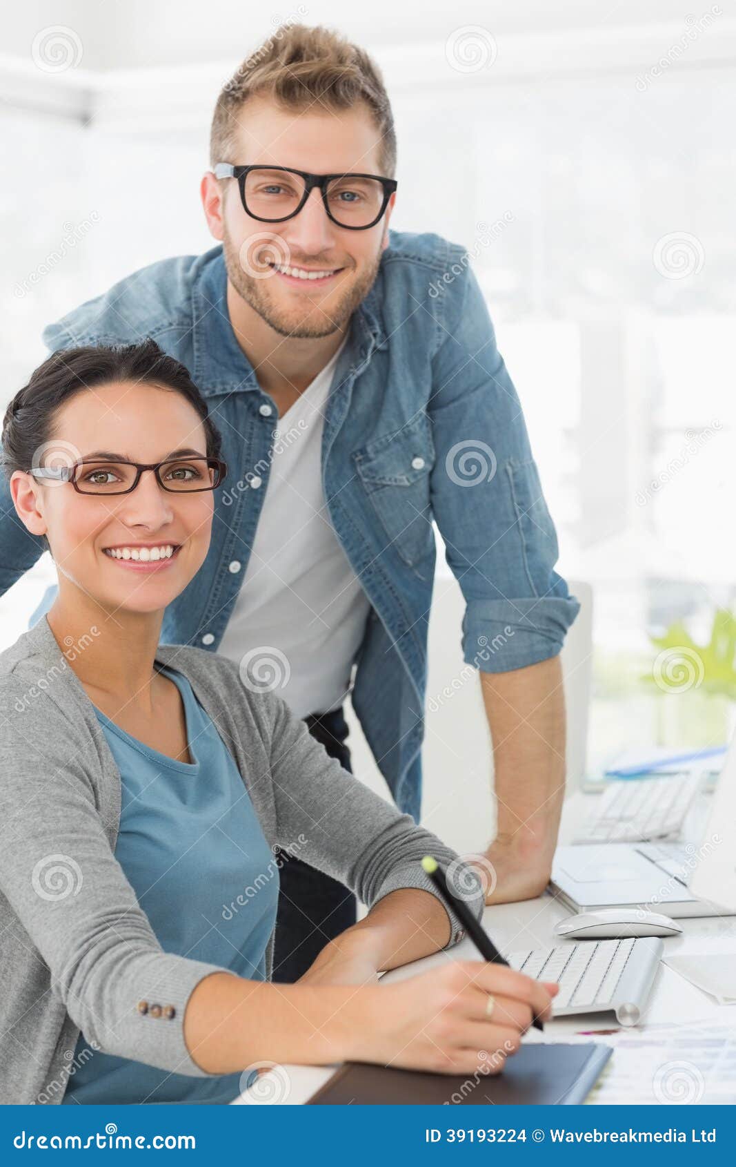 Young Attractive Design Team at Desk Smiling at Camera Stock Photo ...