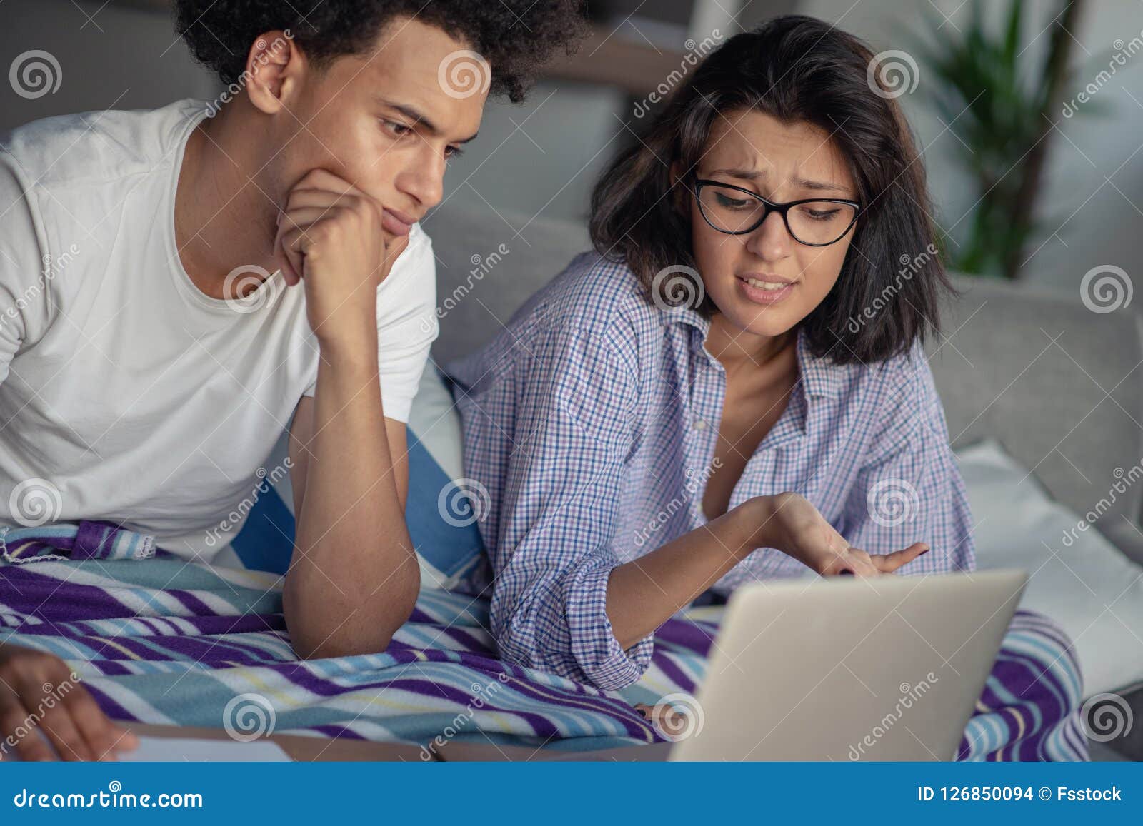 Young Attractive Diverse Couple Browsing Internet, Using Laptop ...