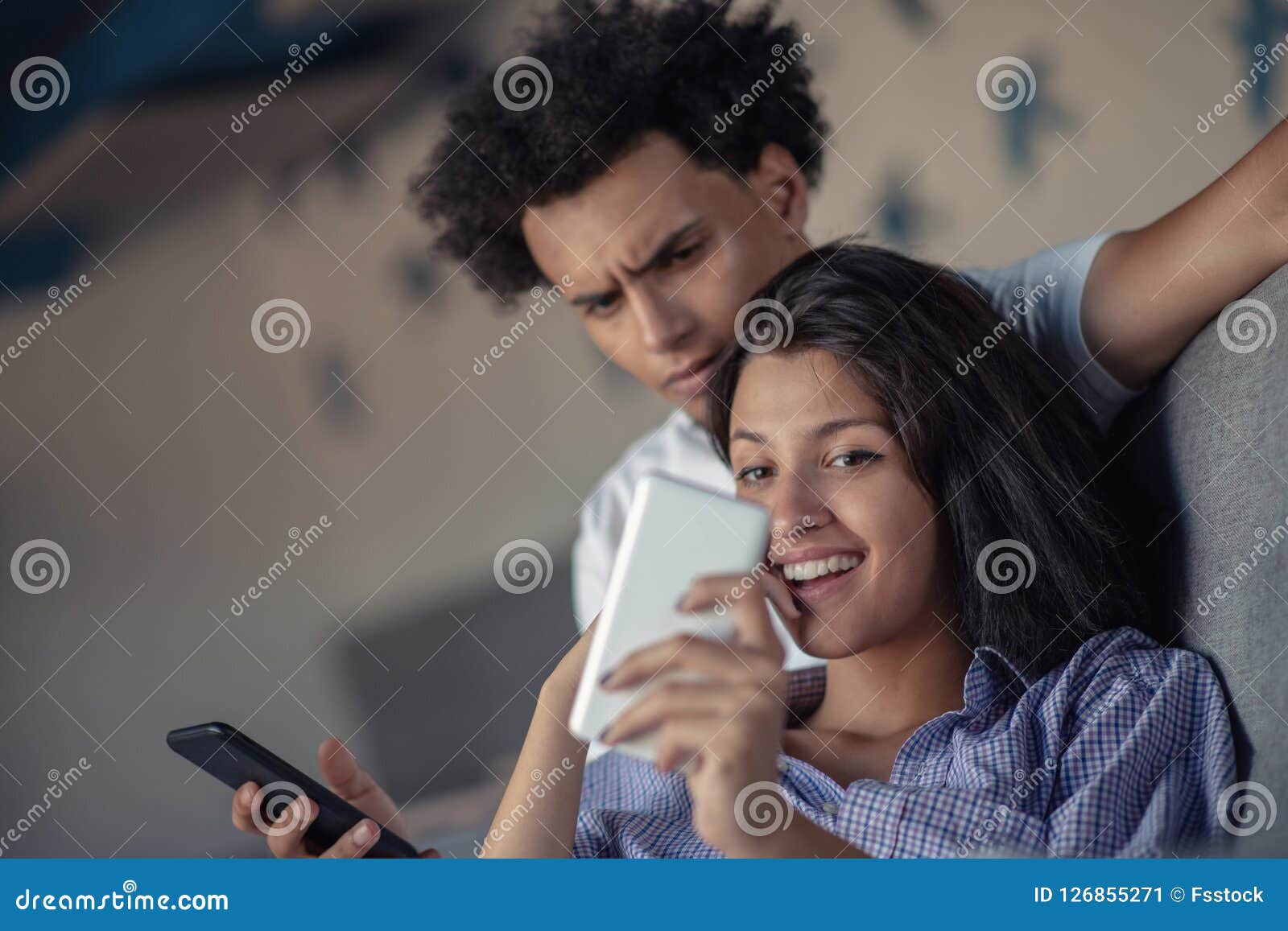 Young Attractive Diverse Couple Browsing Internet, Using Laptop ...