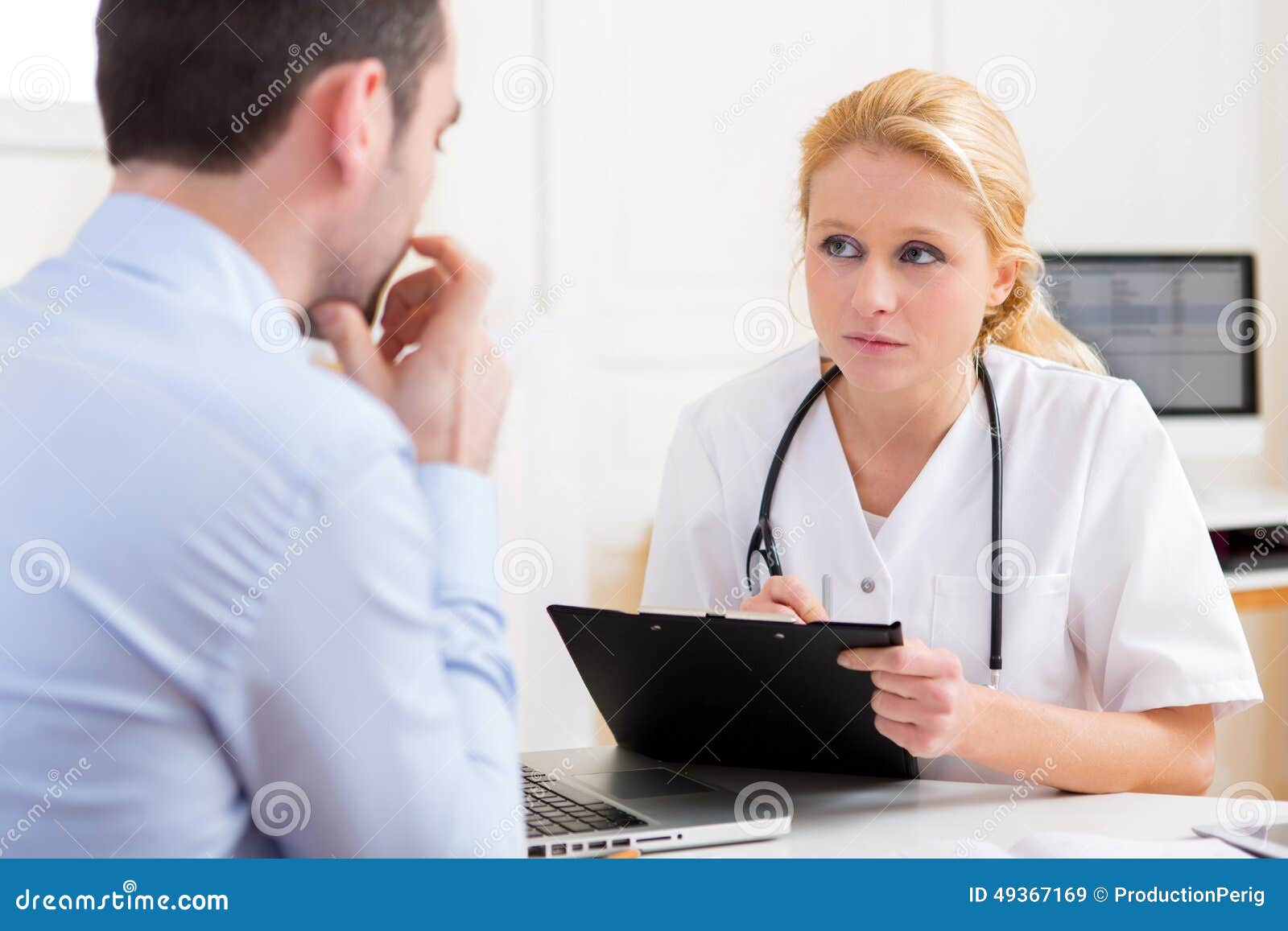 Young Attractive Doctor Taking Notes while Patient Speaking Stock Image ...
