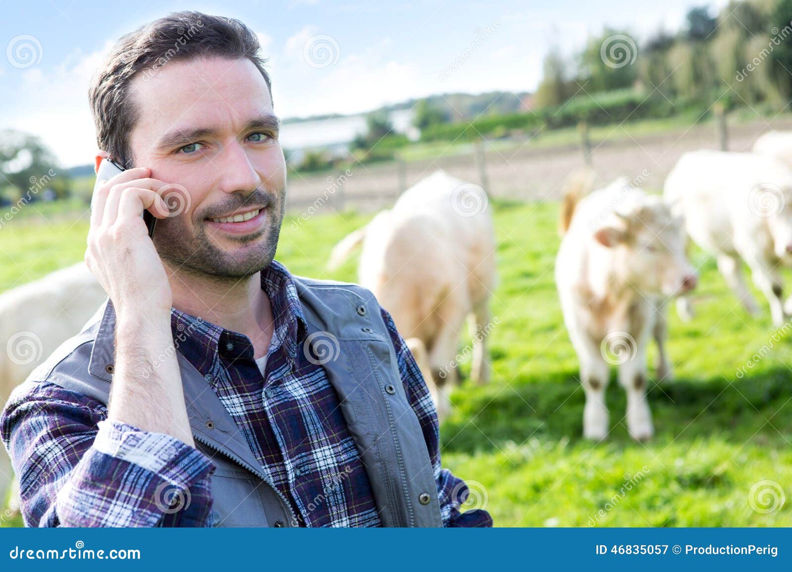 Young Attractive Farmer Using Mobile Phone in a Field Stock Image ...