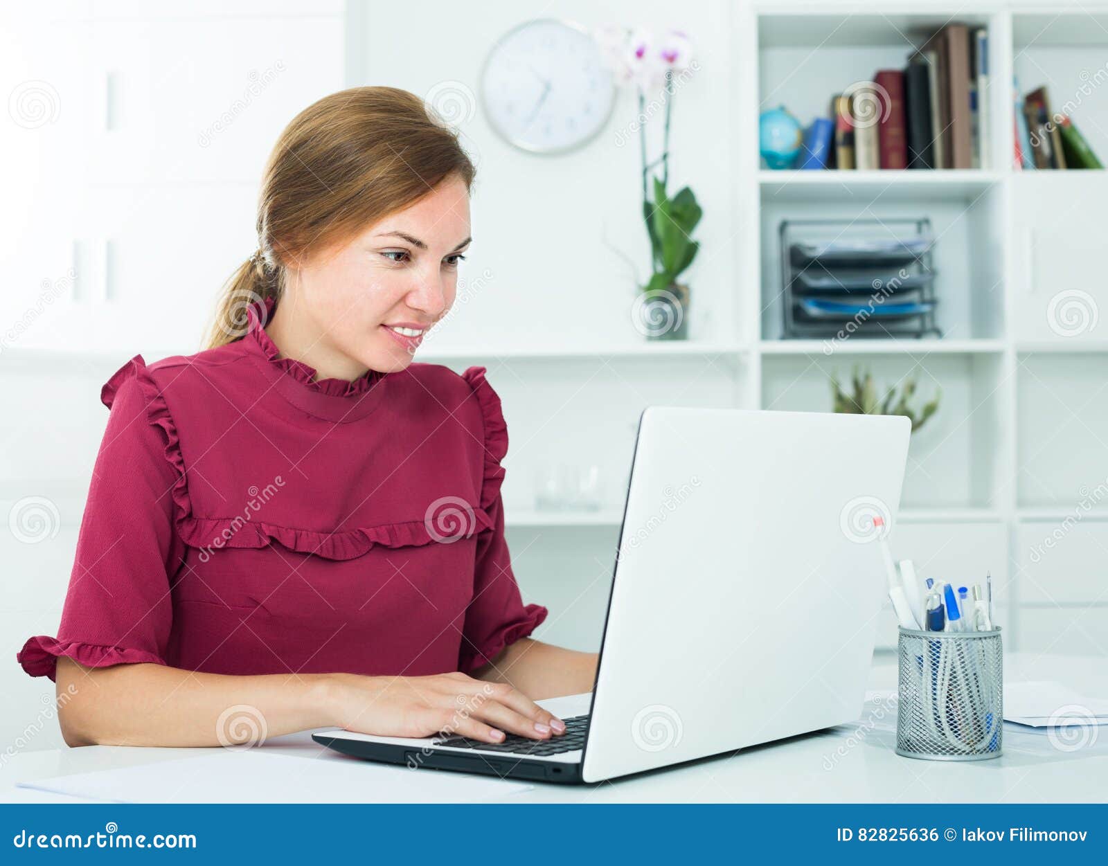 Young Attractive Female Employee Typing on Portable Computer Stock ...