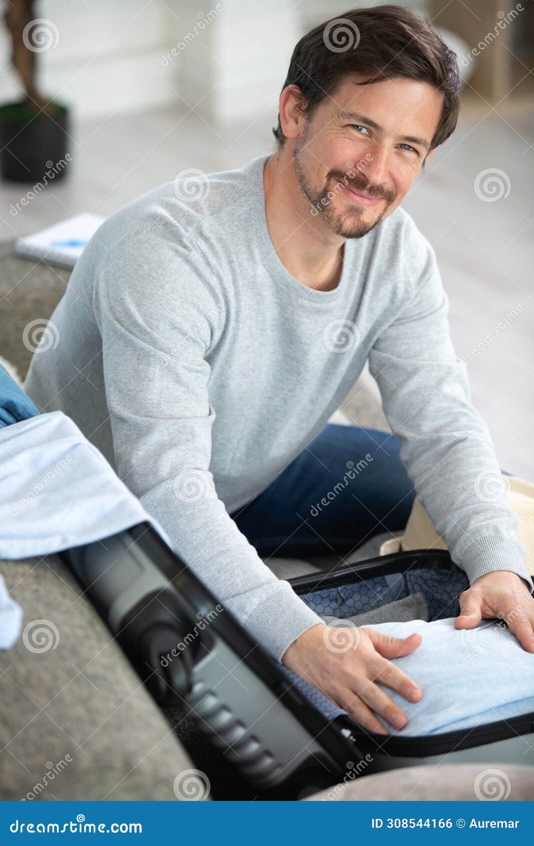 Young Attractive and Happy Man Packing Suitcase Stock Photo - Image of ...