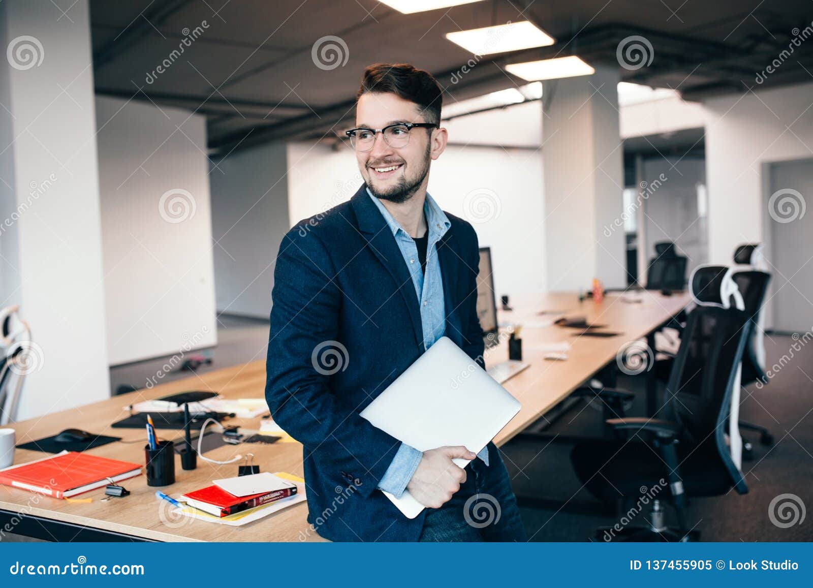 Young Attractive Man In Glassess With Beard Is Standing Near The