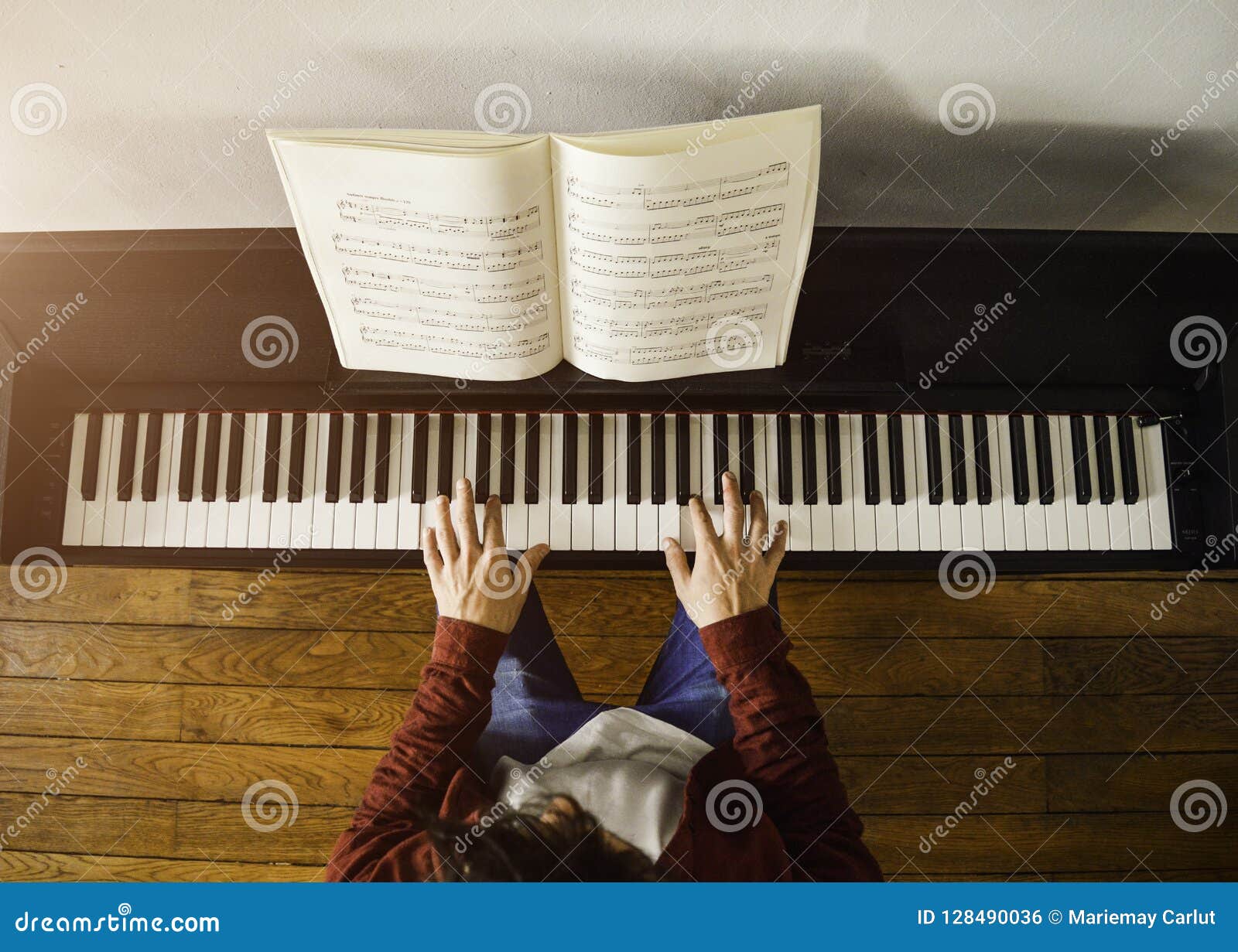 Young Attractive Man Playing Piano Reading a Score at the Sunlight ...