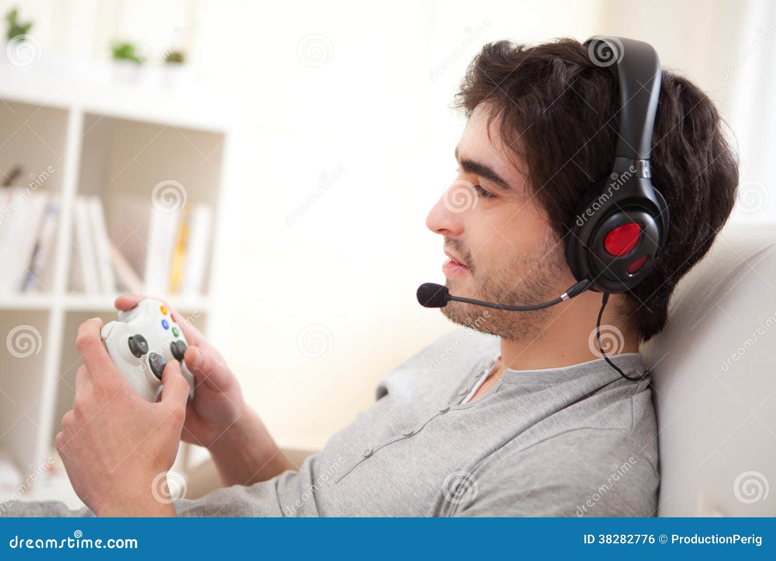 Young Attractive Man Playing Video Games in a Sofa Stock Photo - Image ...