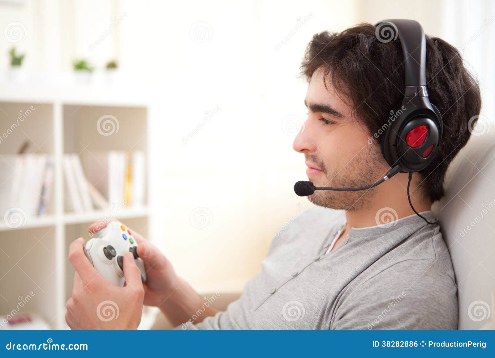 Young Attractive Man Playing Video Games in a Sofa Stock Photo - Image ...