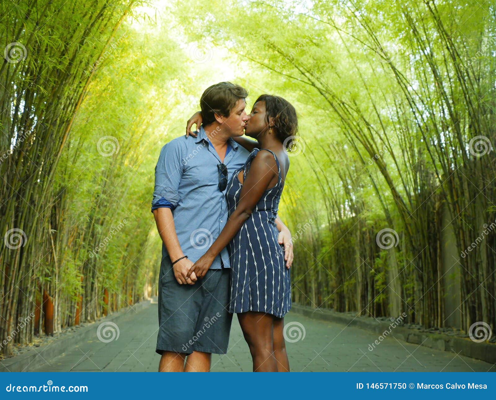 Young Attractive Mixed Ethnicity Couple Kissing Outdoors With