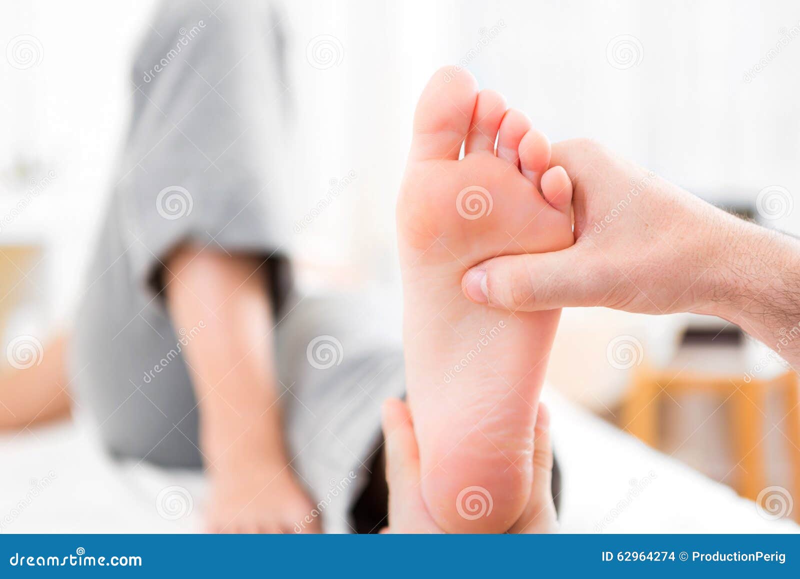 Young Attractive Physiotherapist Doing Reflexology on a Patient Stock ...