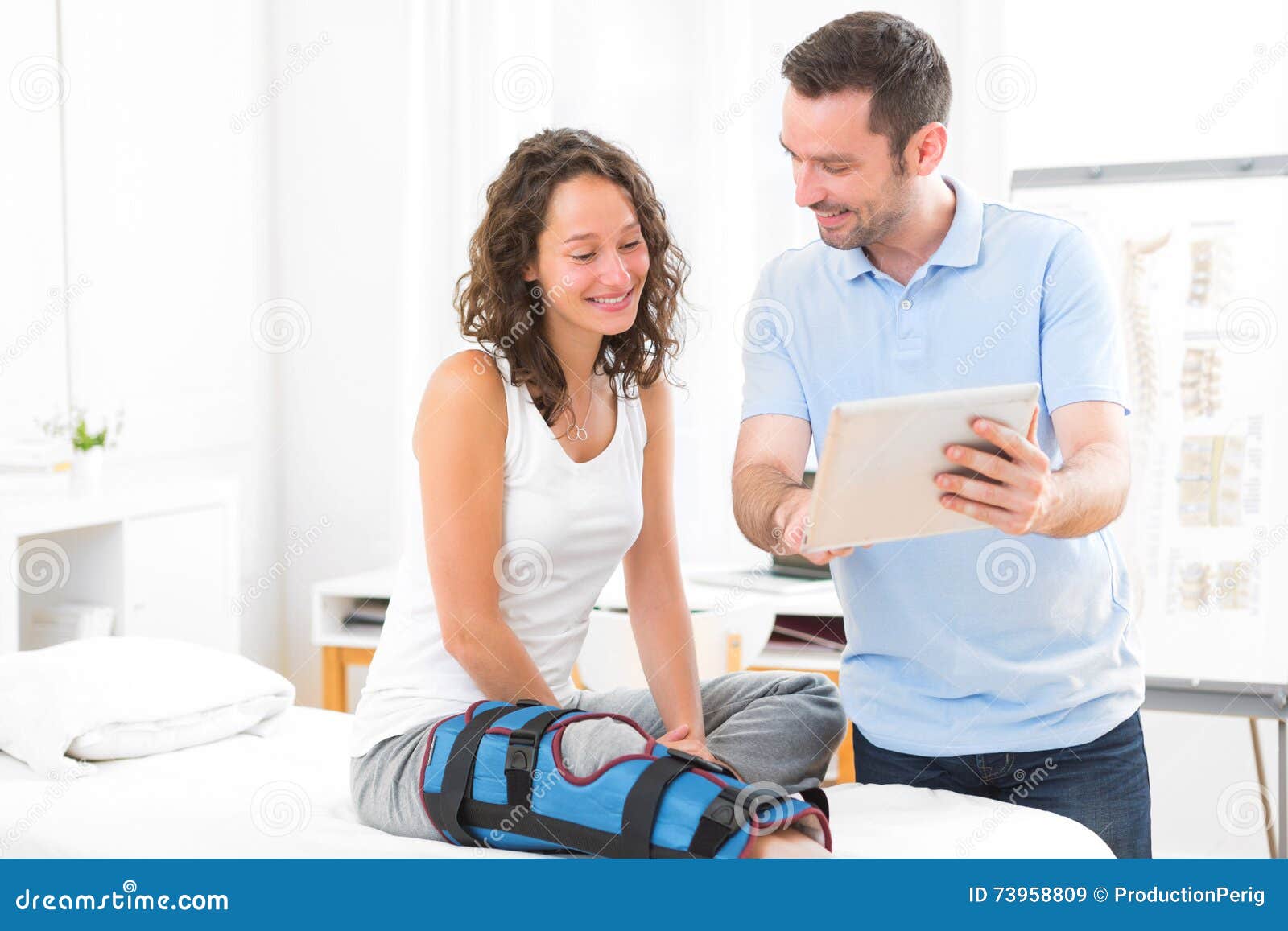 Young Attractive Physiotherapist Using Tablet with Patient Stock Image ...