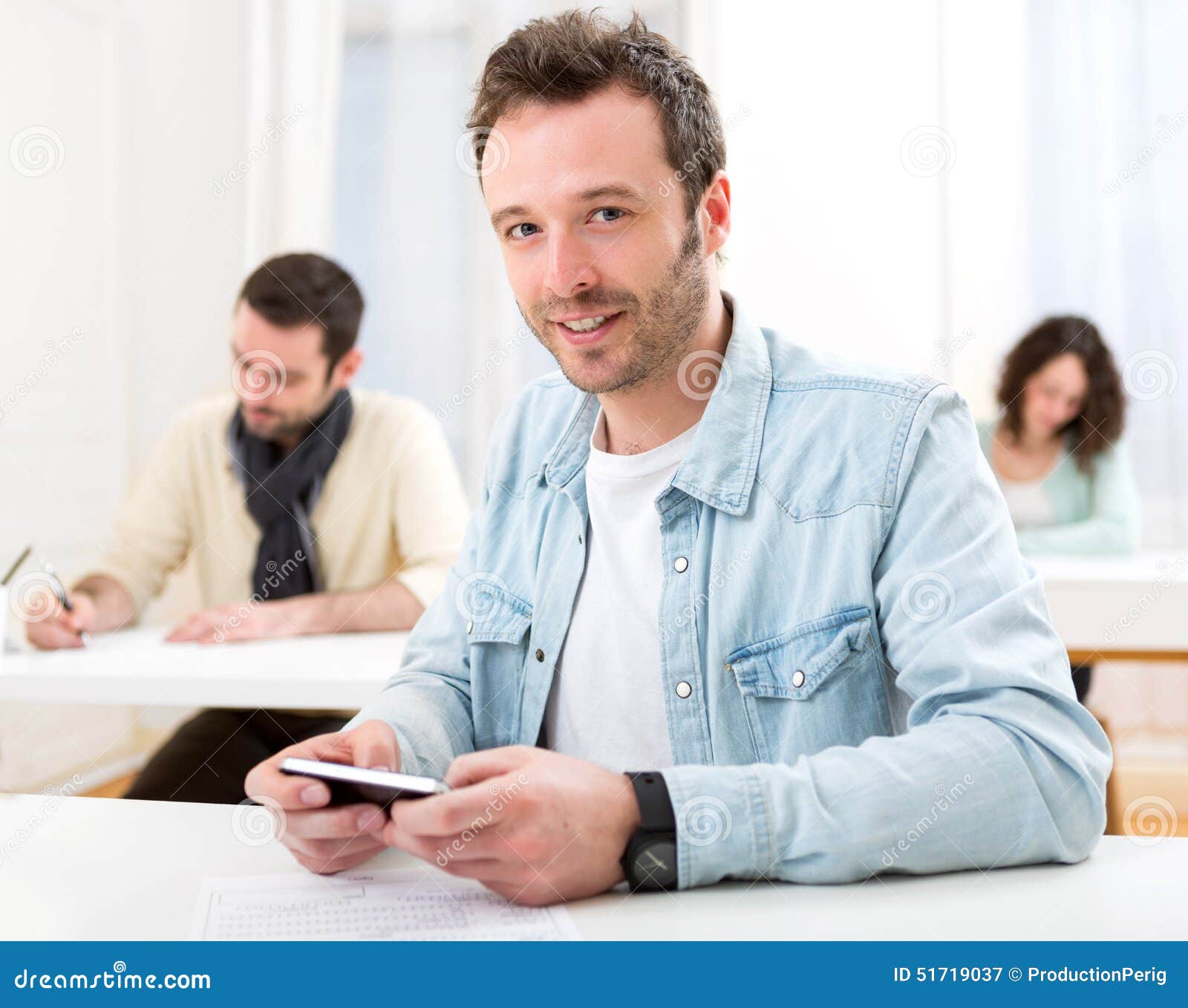 Young Attractive Student Using His Mobile during Classes Stock Image ...